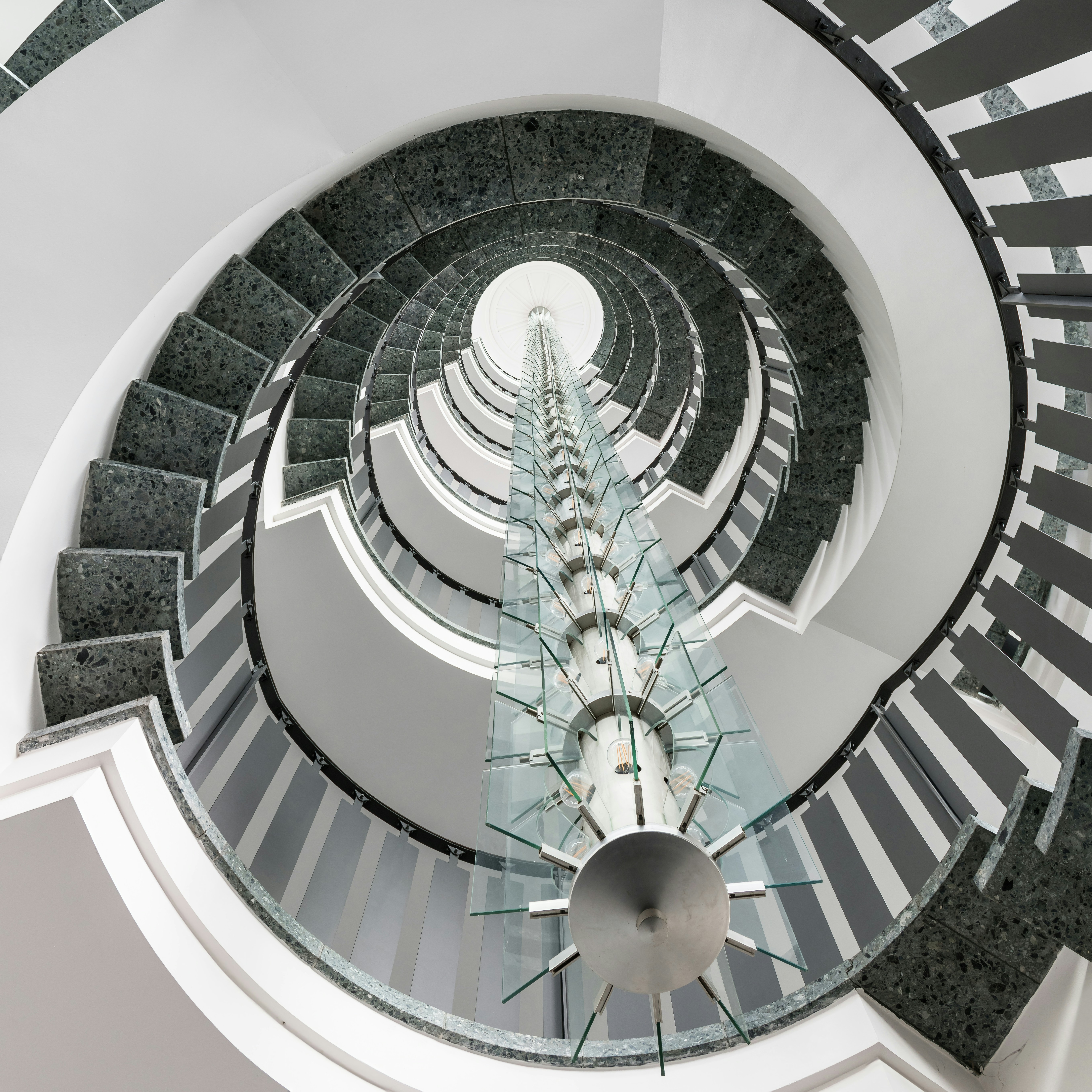 Spiral Atrium: A Glass Spine Descending through Concrete Rings