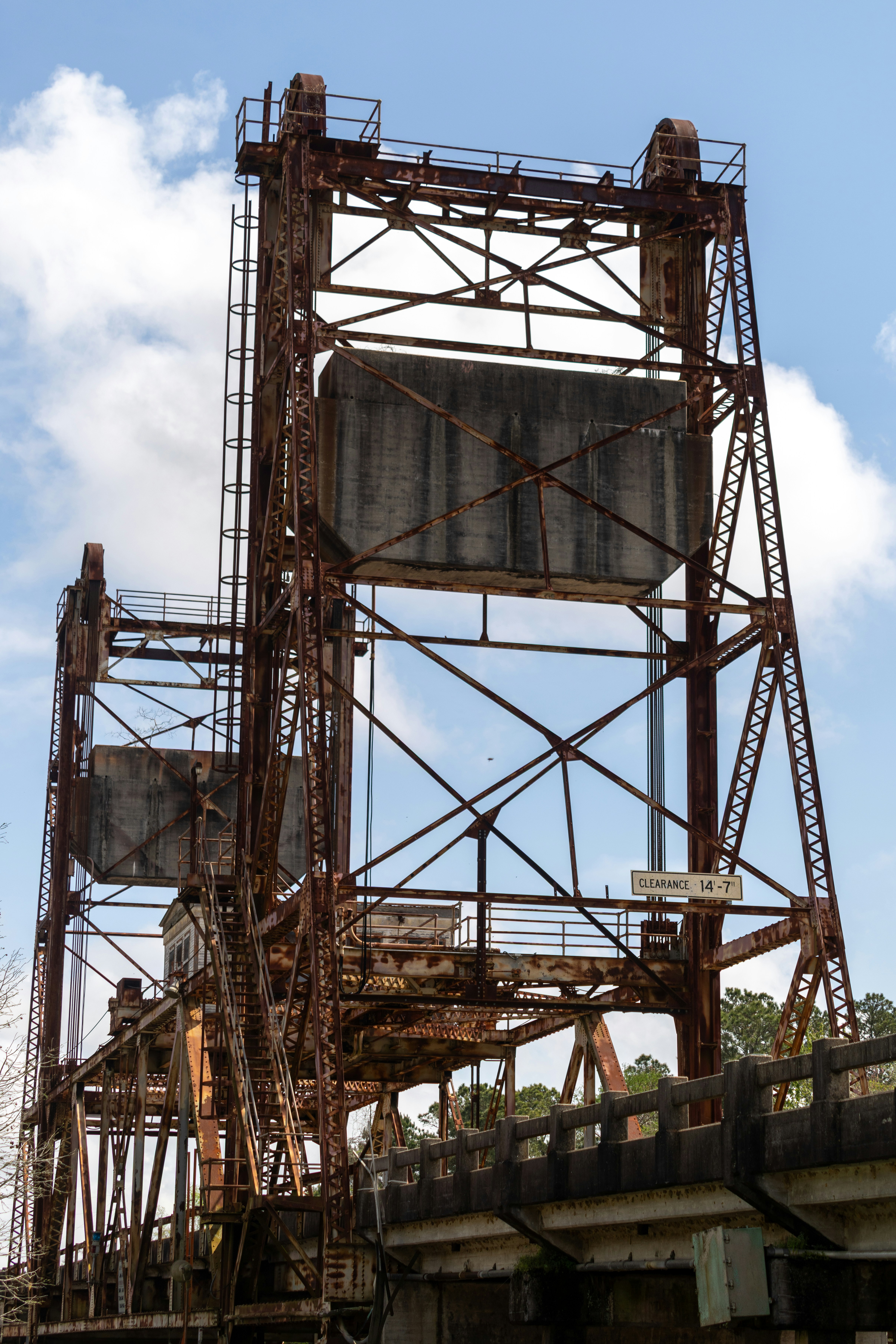Industrial Skeleton: Rusted Gantry Tower Stands Against a Clear Sky