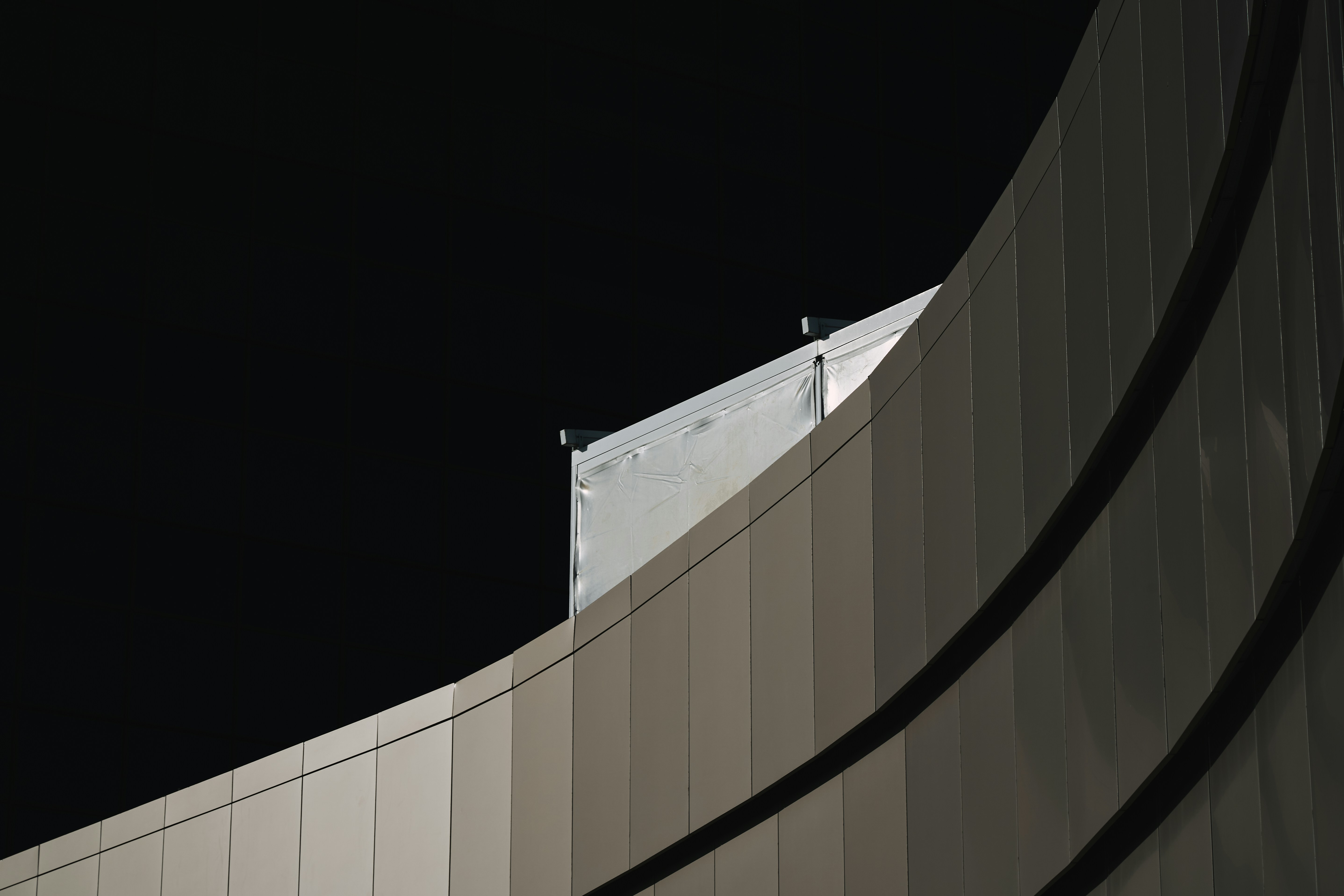 Minimalist Reveal: Silver Curves and a Sliver of Sky
