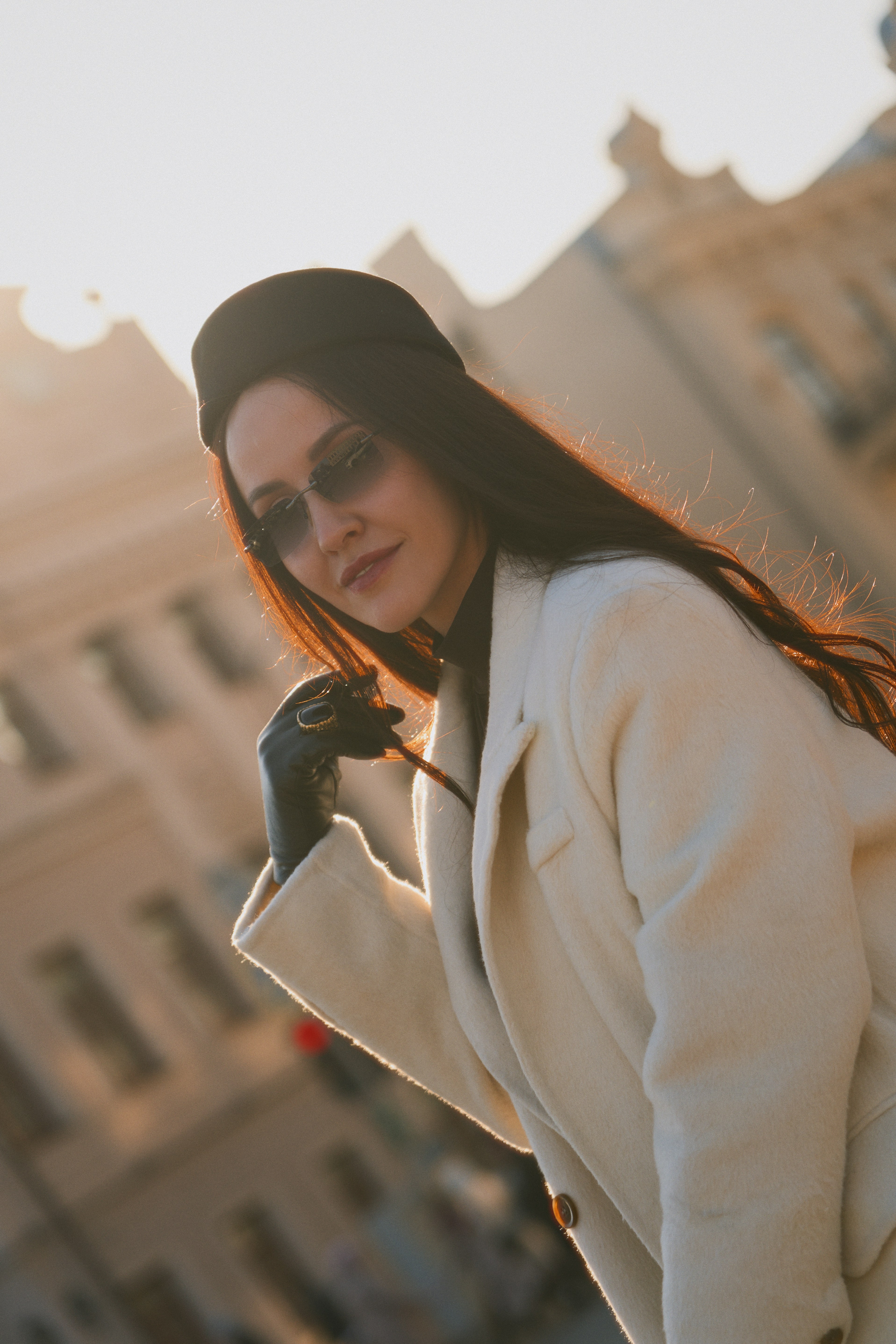 City chic in a sunlit tilt: a confident stride in winter white