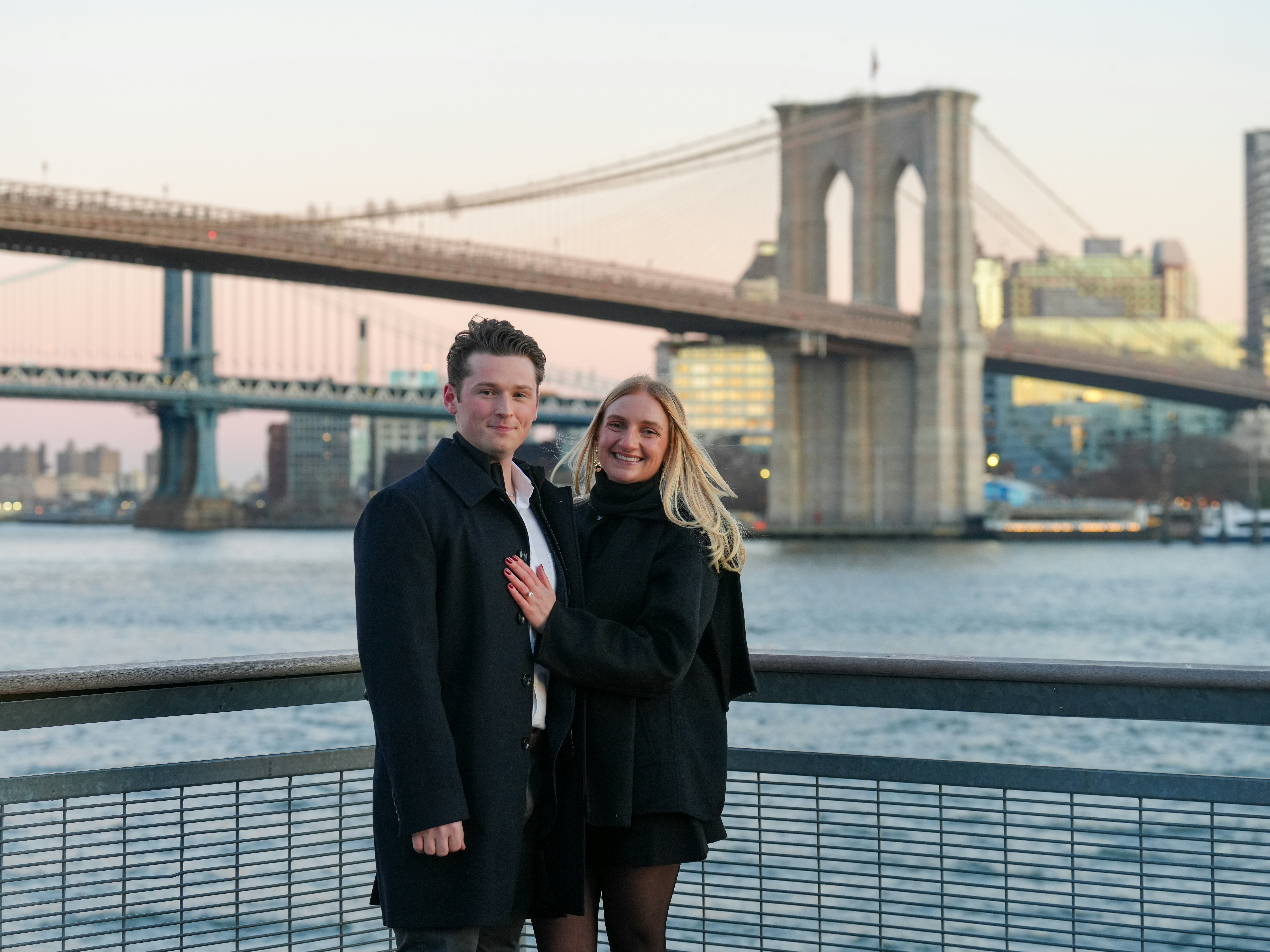 Couple by the Waterfront Under the Bridge