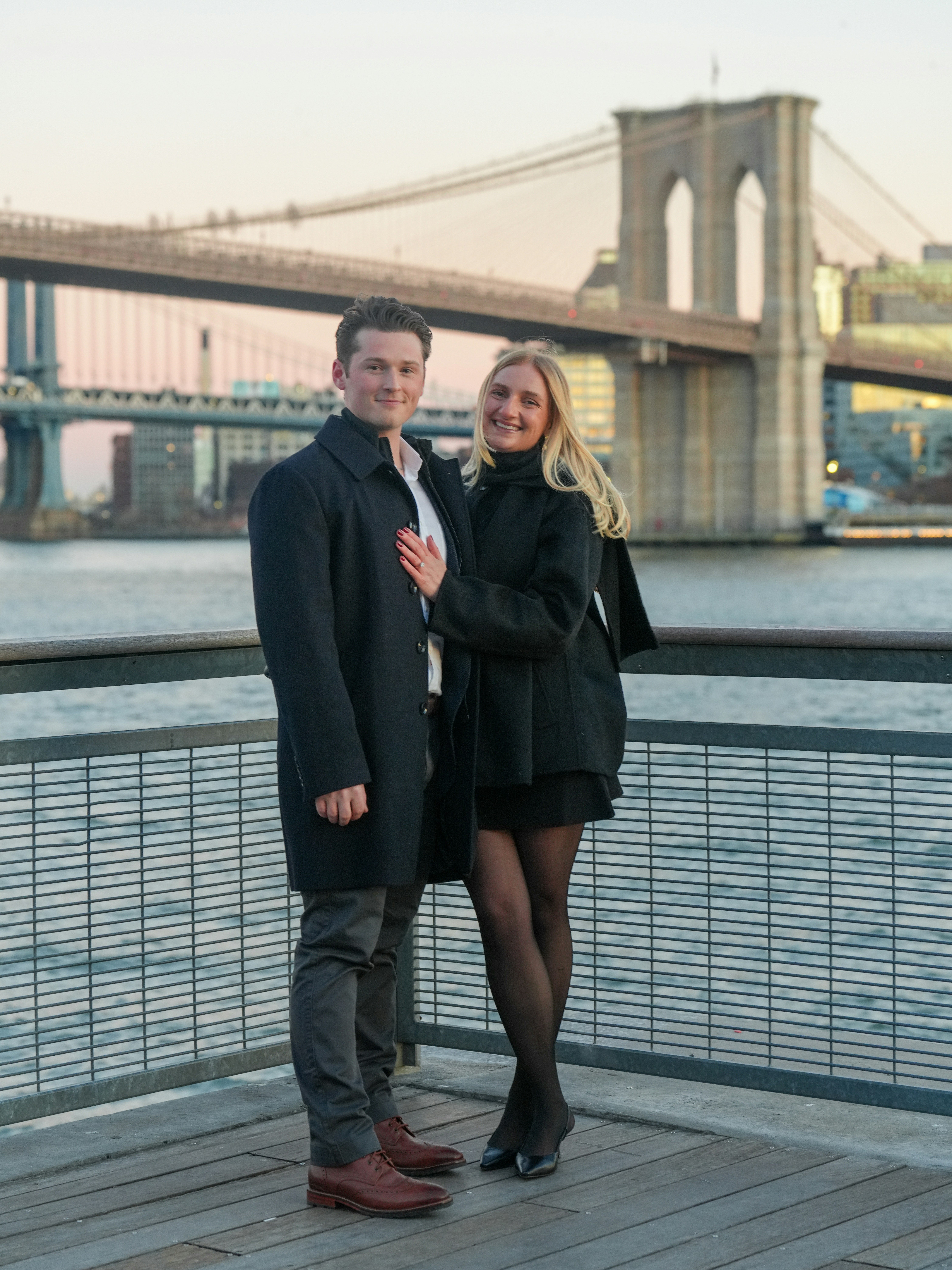 Bridge-side embrace: a couple portrait by the river
