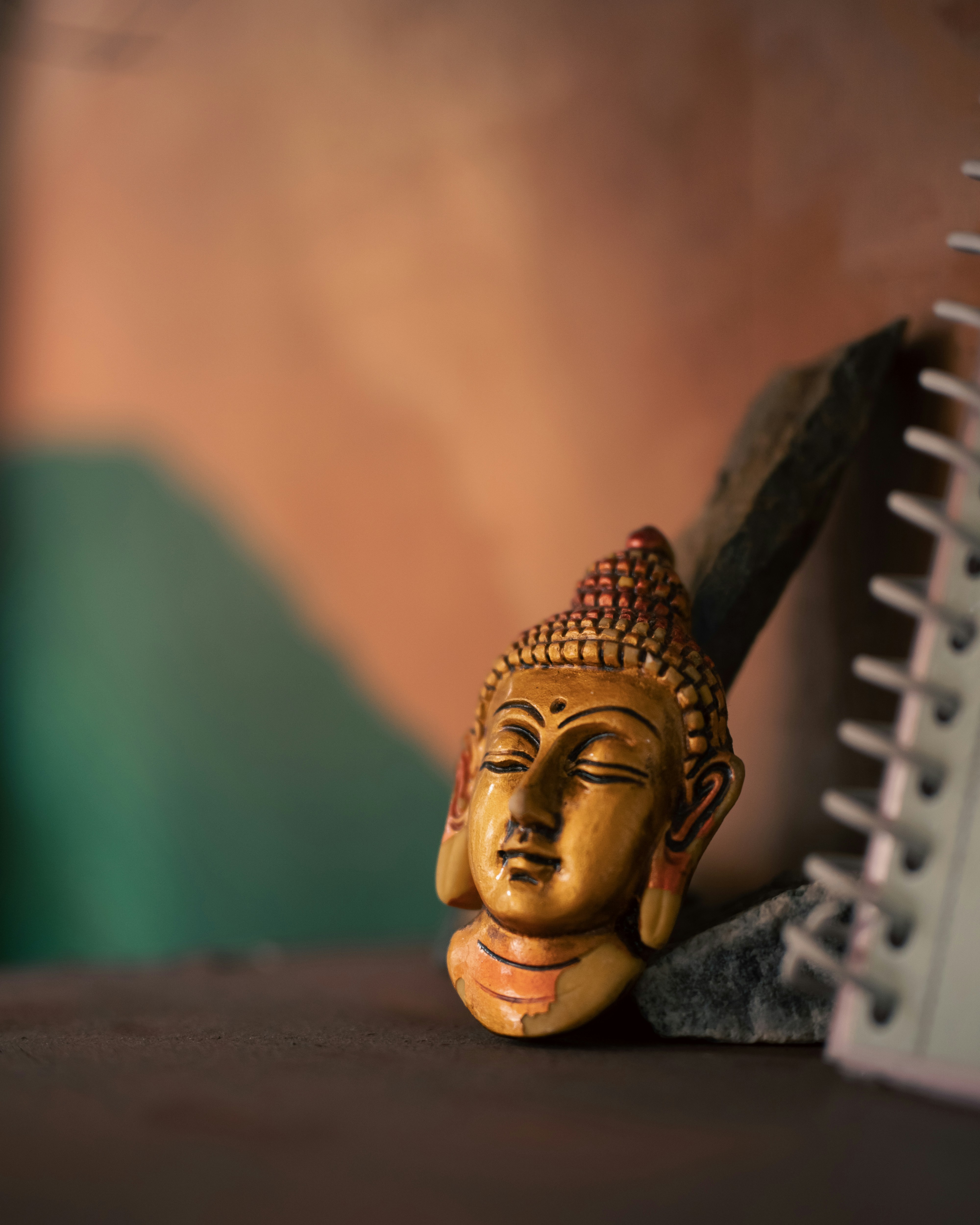 Golden Buddha Head Resting Against a Stone Slab