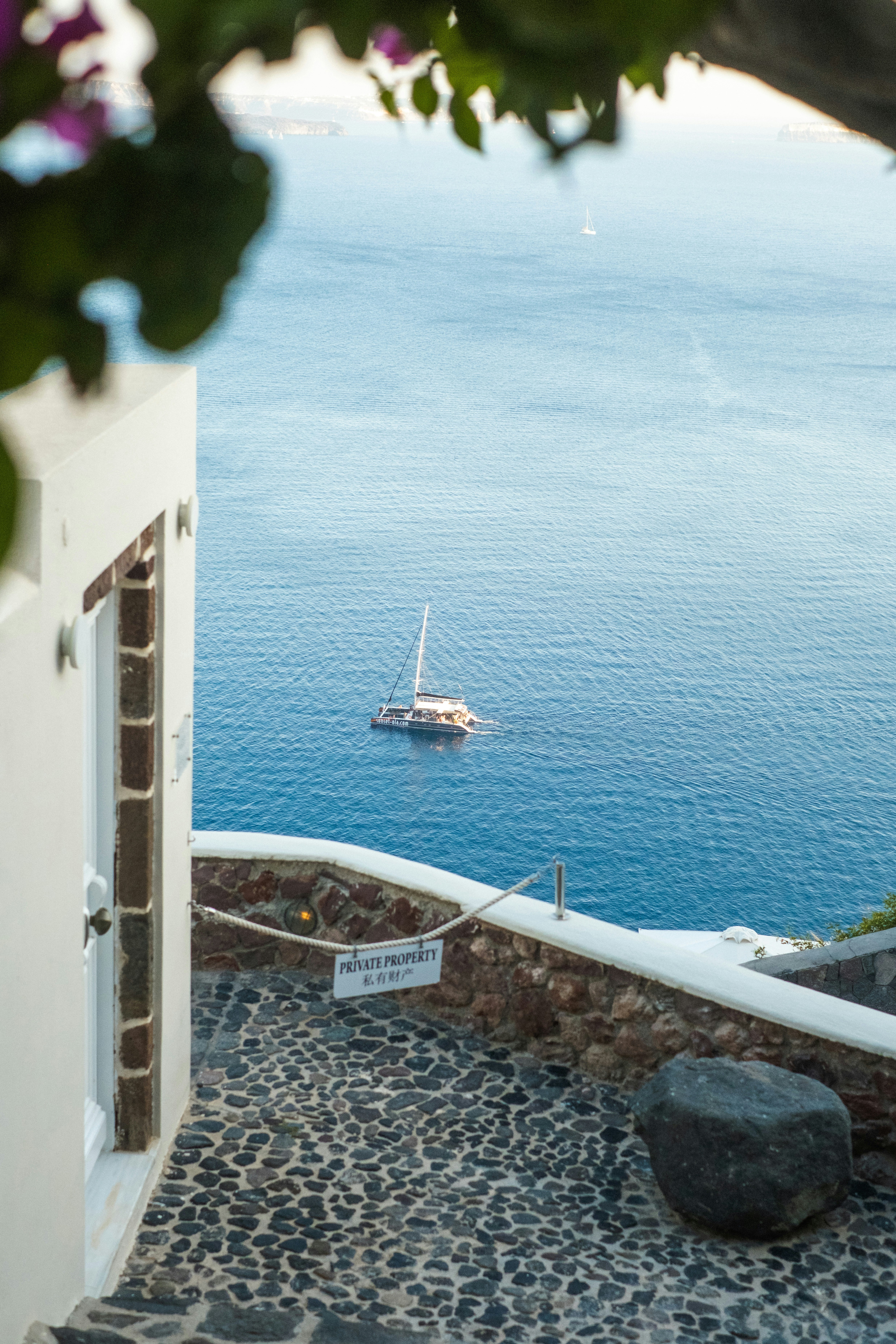Sea Terrace with Sailboat Beneath Framed Foliage