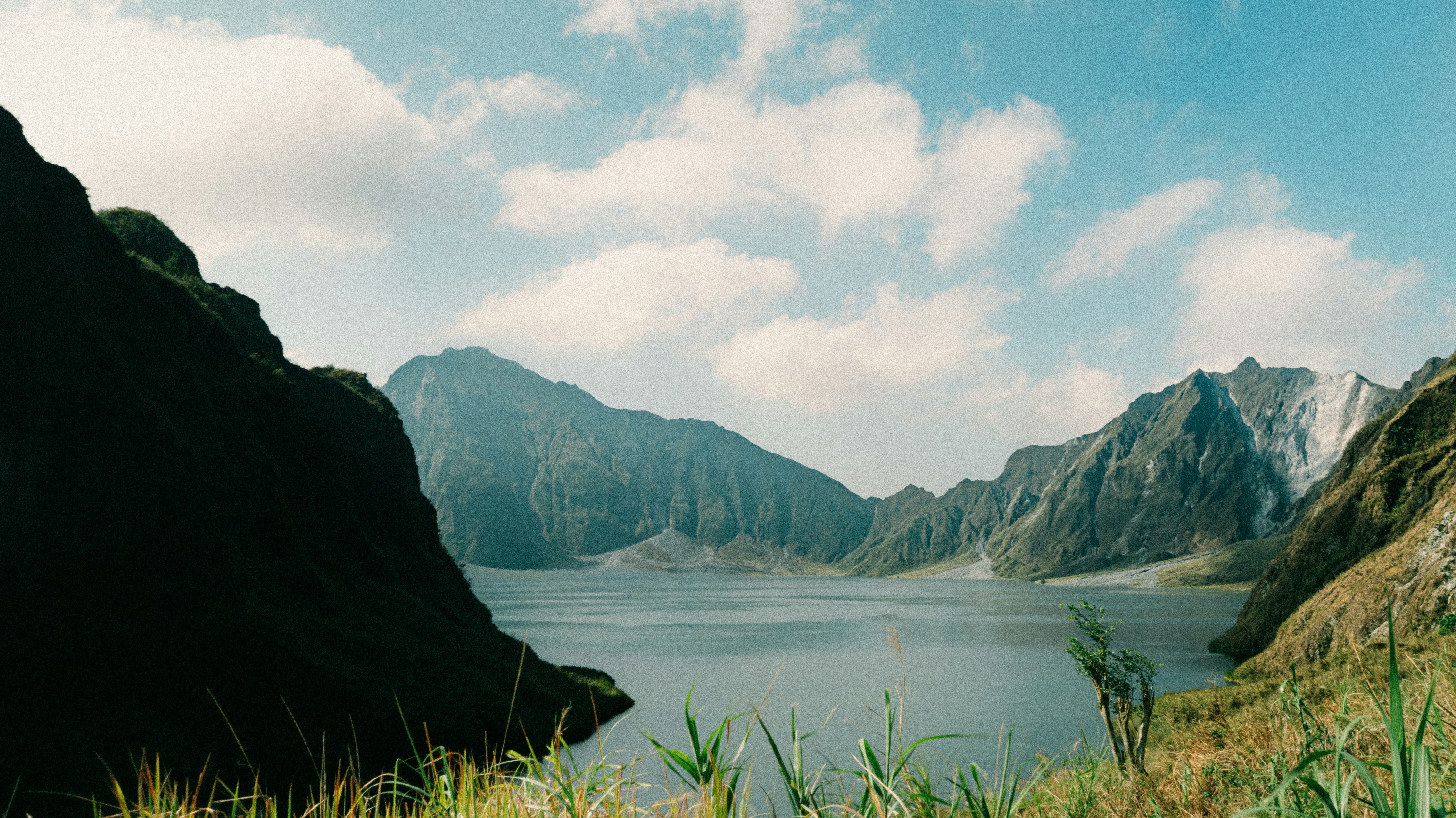 Glacial Lake Amid Cloud-Soft Peaks