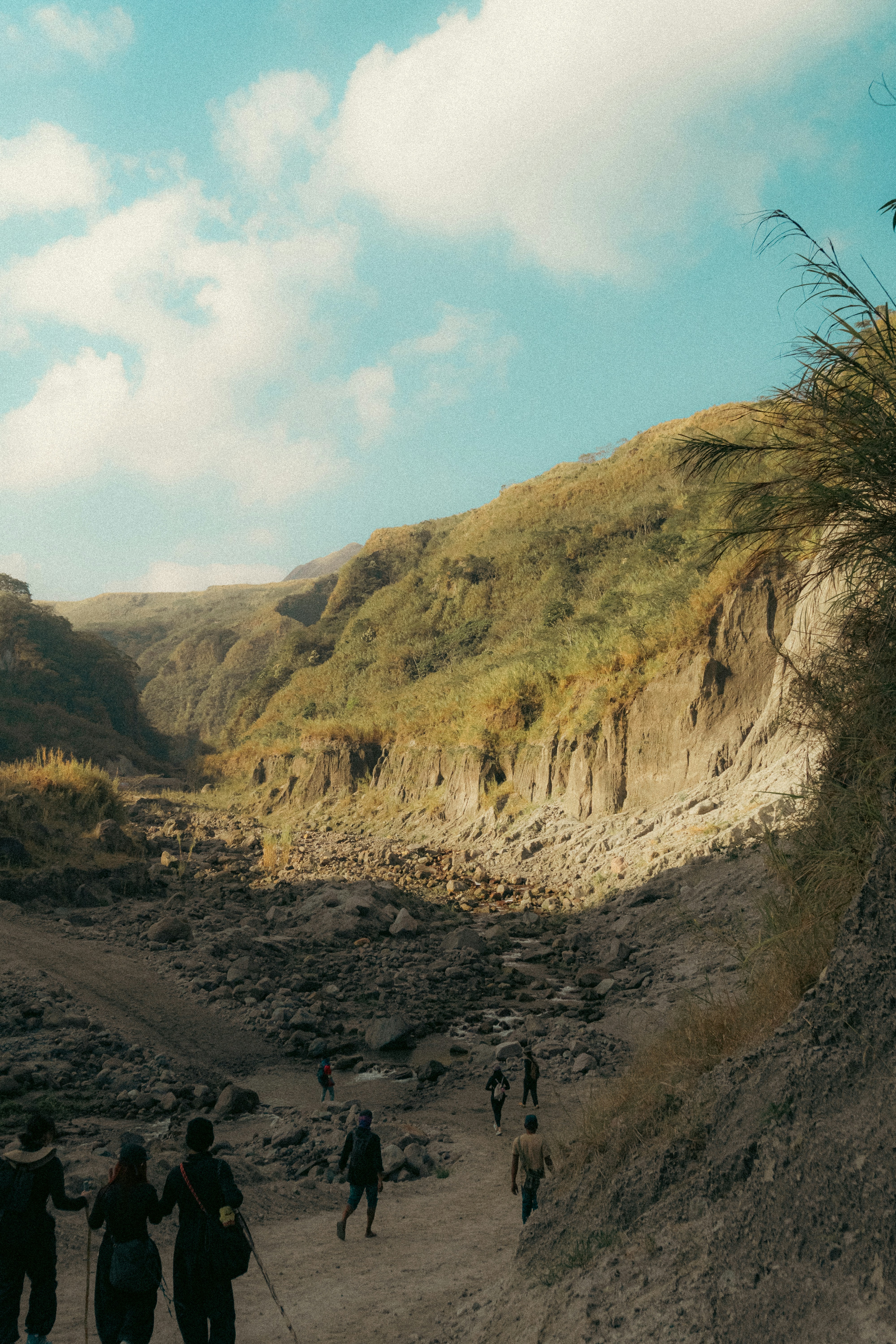 Rugged Valley Ascent: hikers traversing a rocky amphitheater