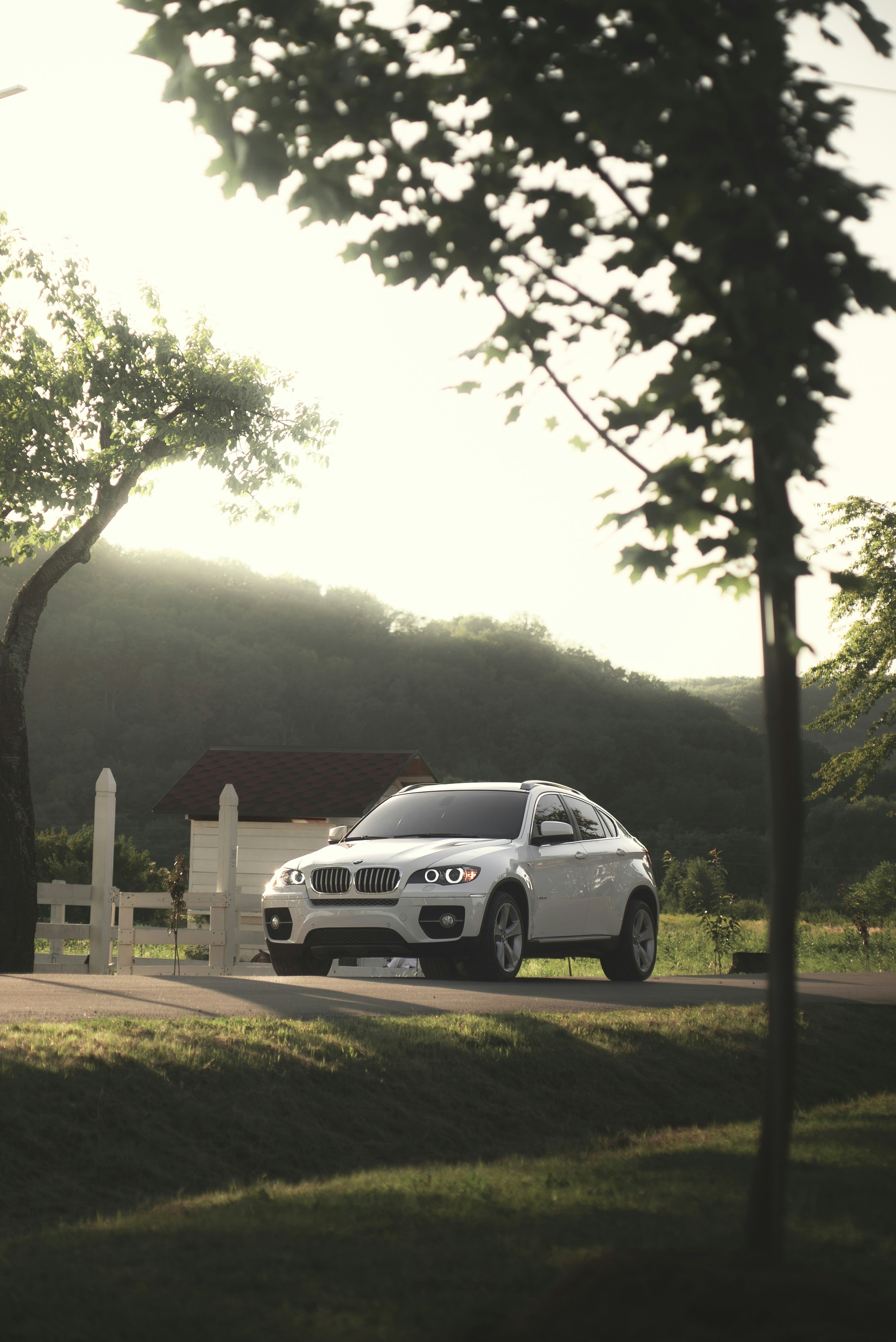 White BMW X3 perched under dawn light in a quiet driveway