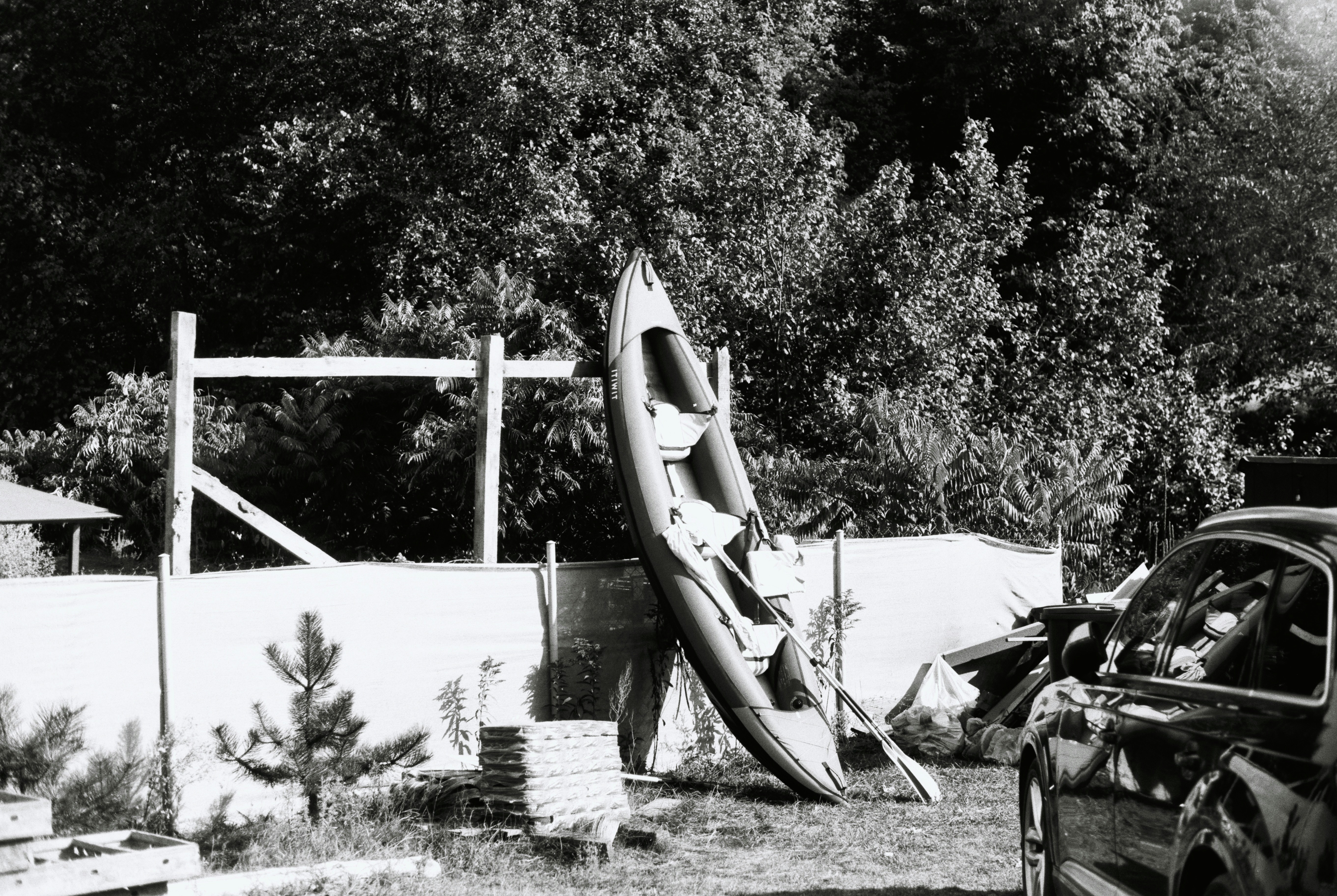 Mulled Quiet: Boat and Car in a Sunlit Yard