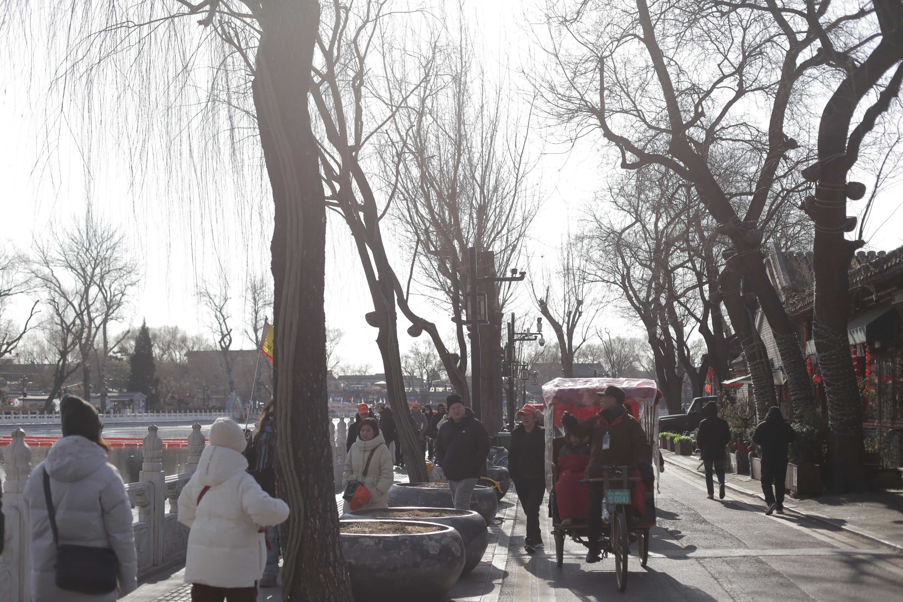 Winter Boardwalk: People Drift Through a Quiet City Park