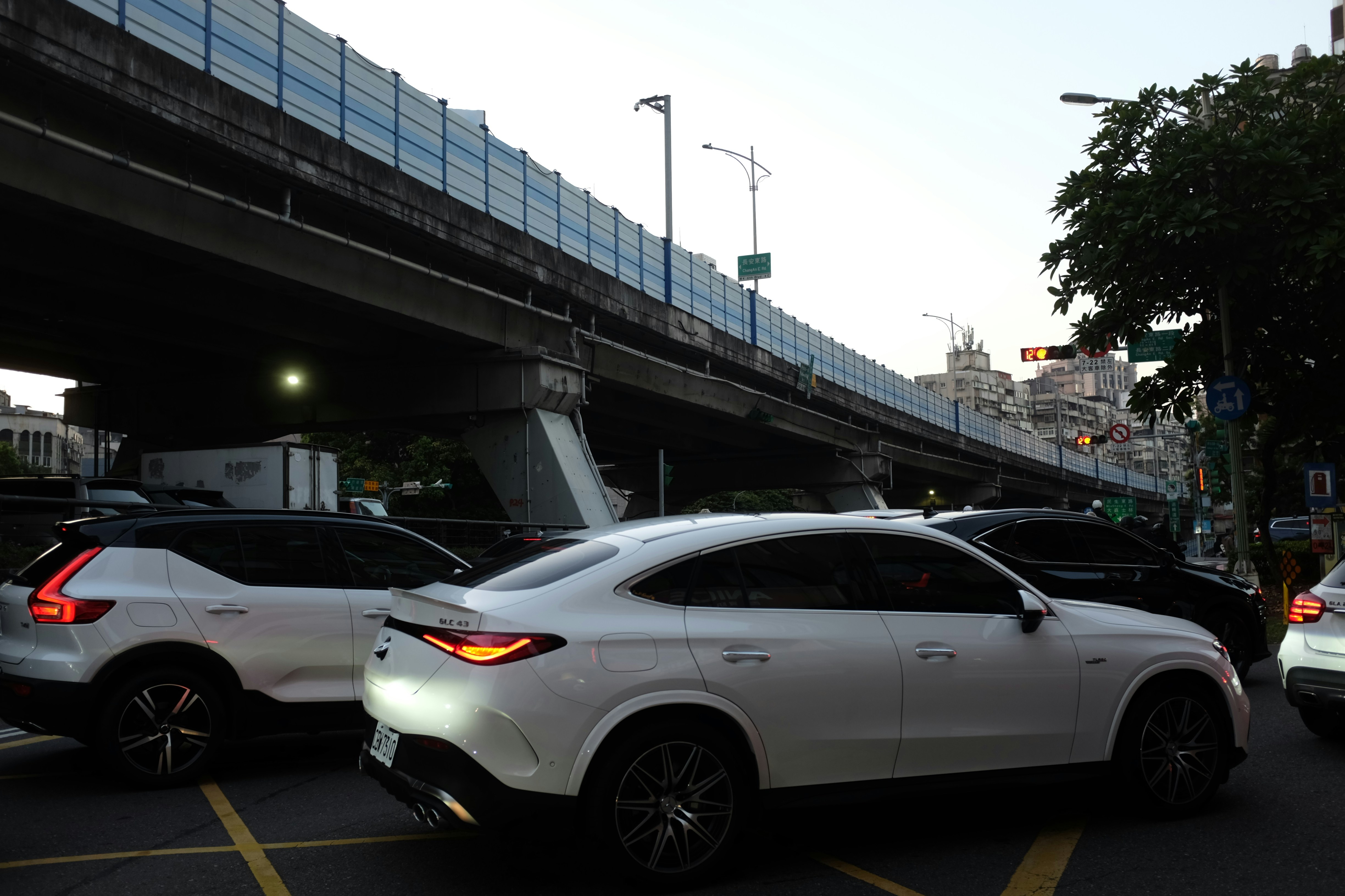 Midday Traffic Halt under a Concrete Overpass