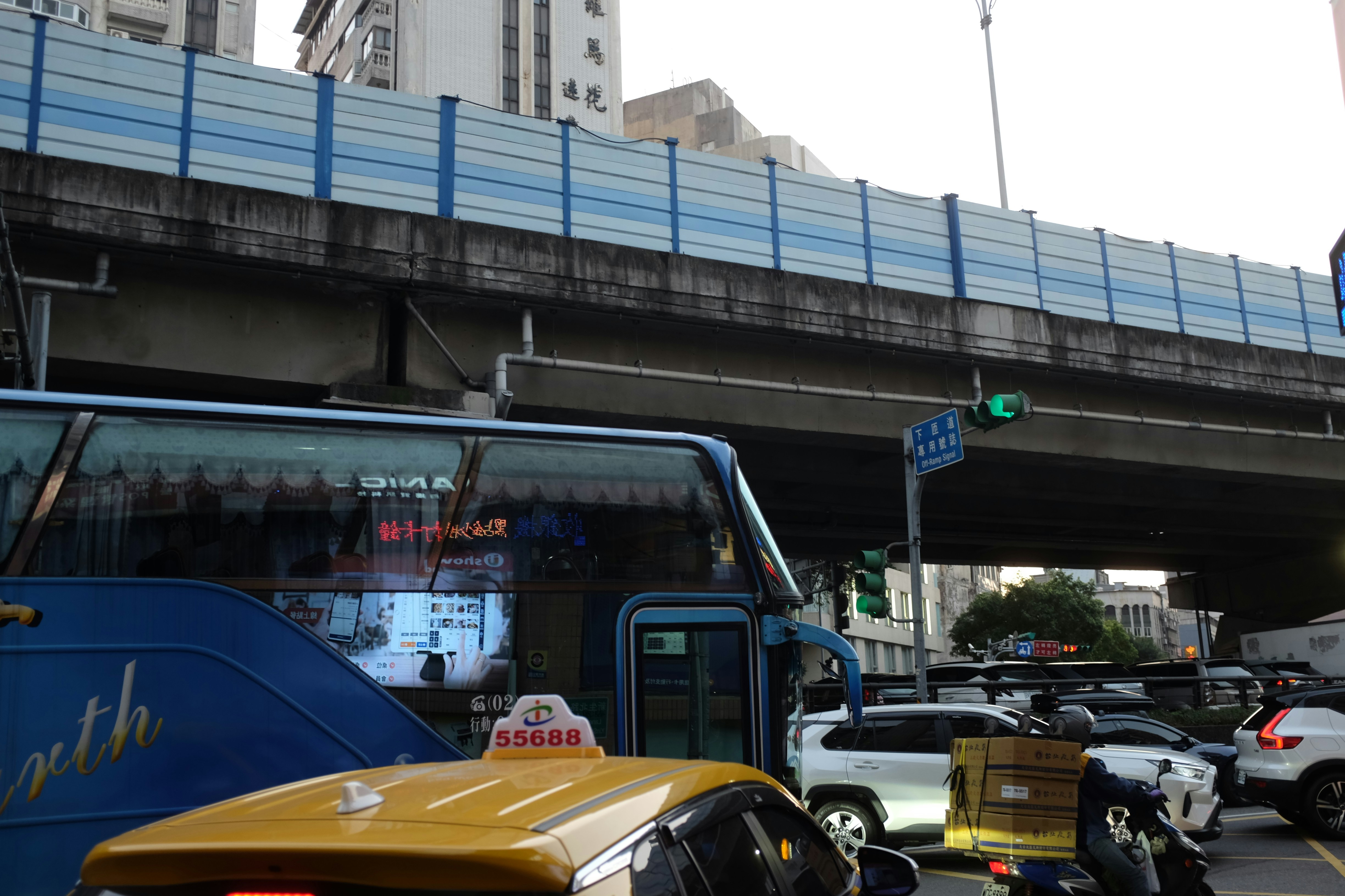 Blue Bus Underpass Rush: A City Street Scene at Dusk