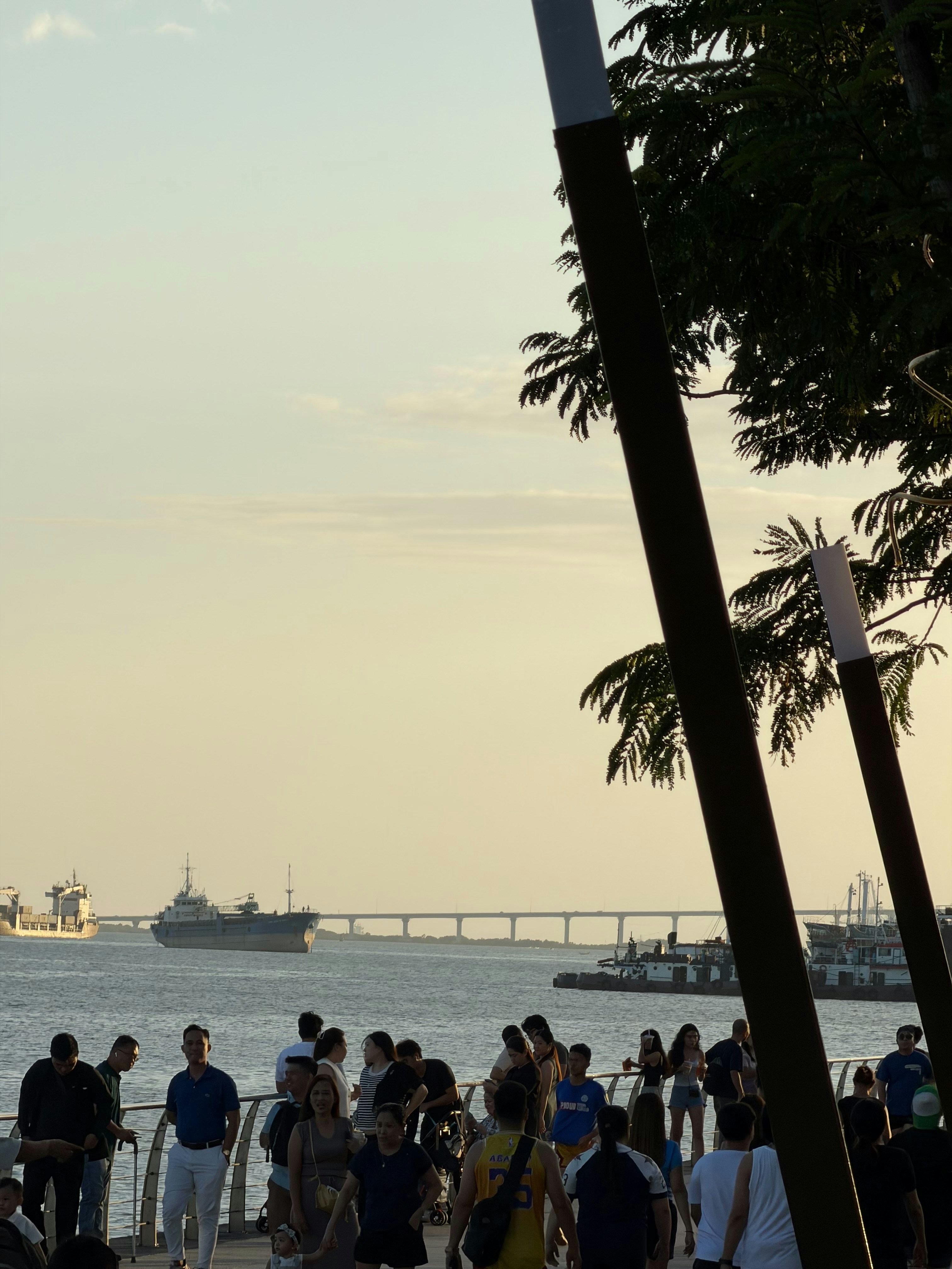 Crowd at the Pier Under Slanted Beams at Dusk