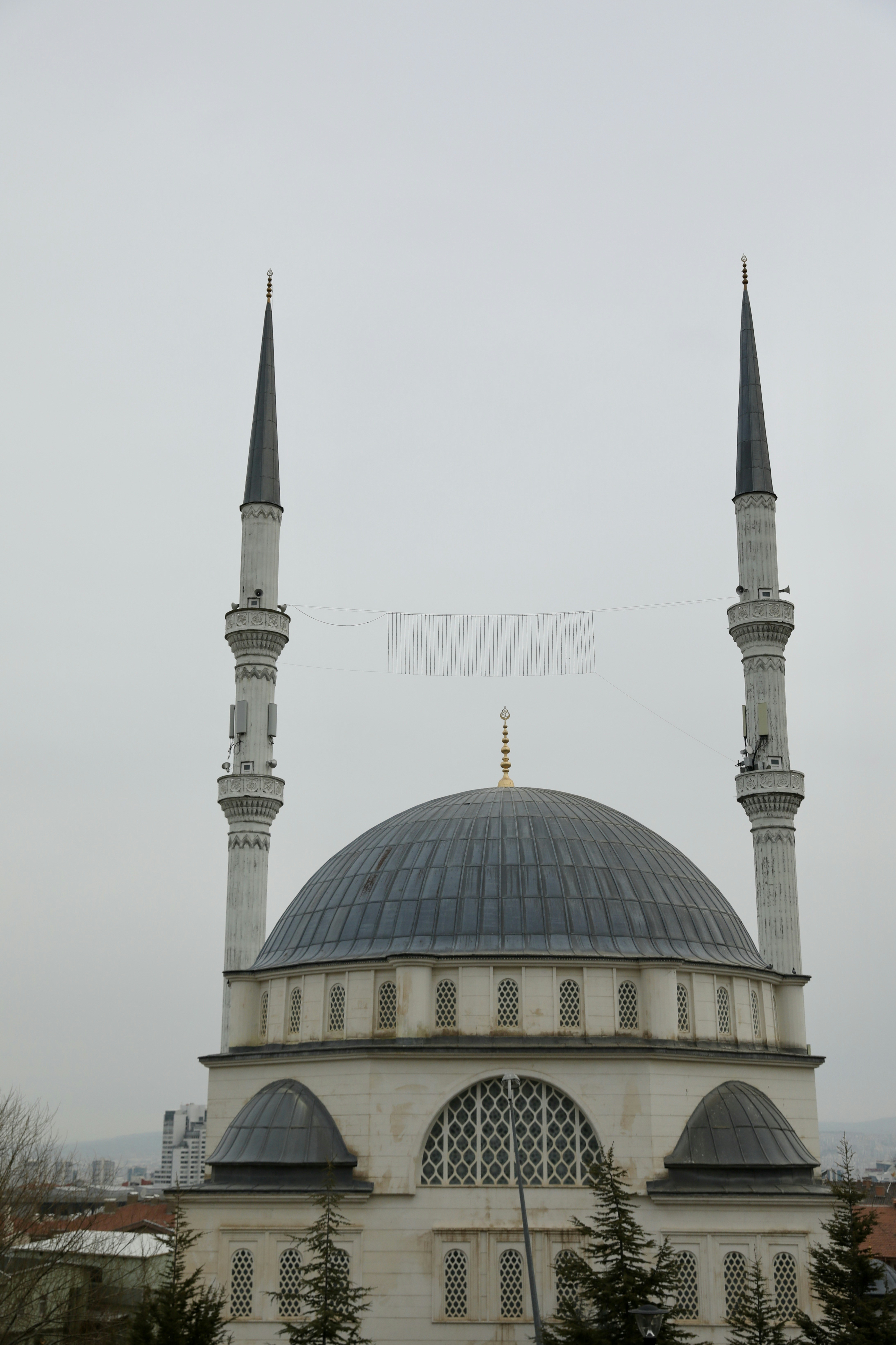 Twin Minarets Framing a Domed Mosque Under Pale Sky