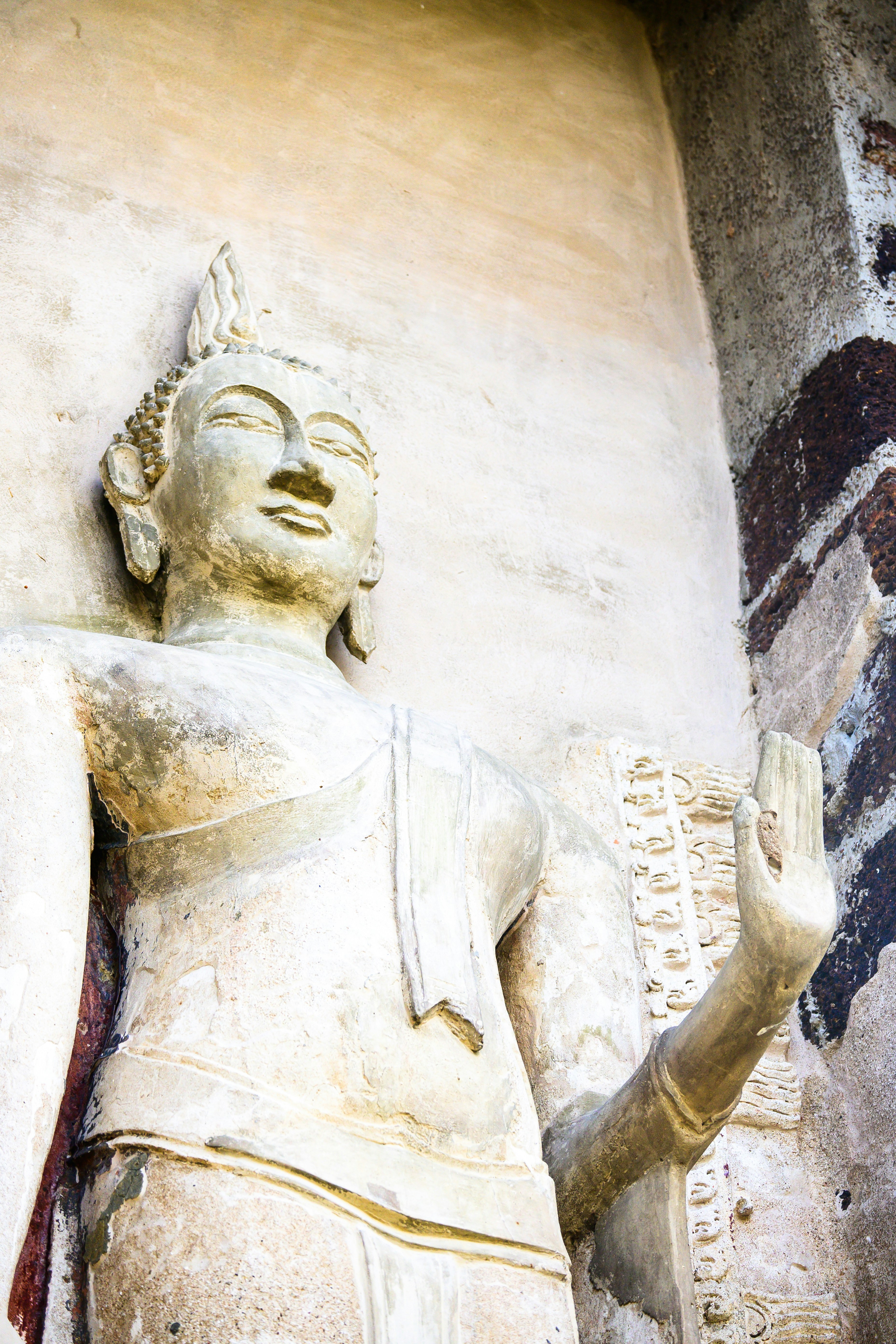 Stone Buddha in Quiet Grotto: A Solitary Gaze of Weathered Serenity