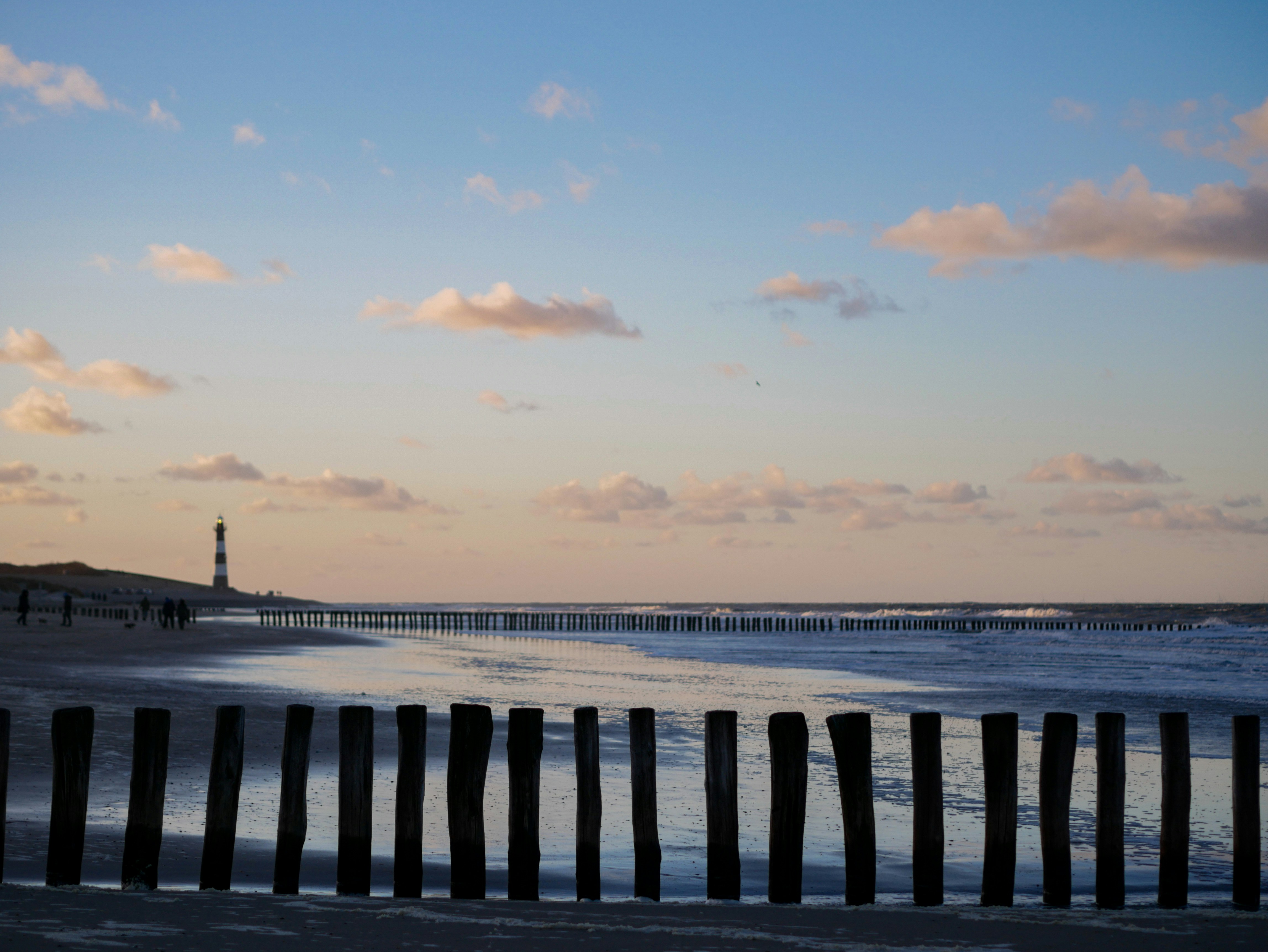 Lighthouse Horizon: Longshore Silhouettes at Dusk