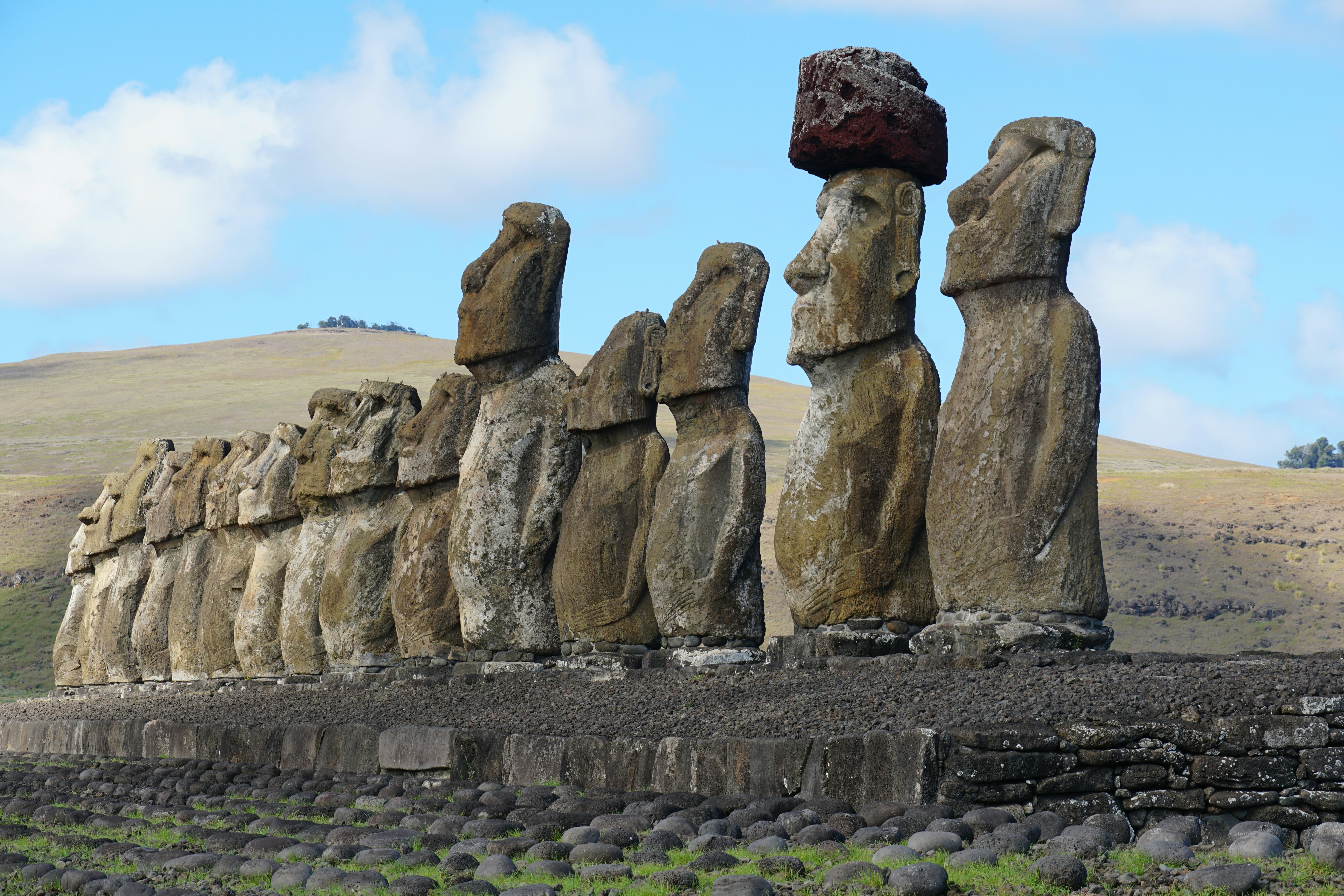Row of Moai Guardians Under a Wide Blue Sky