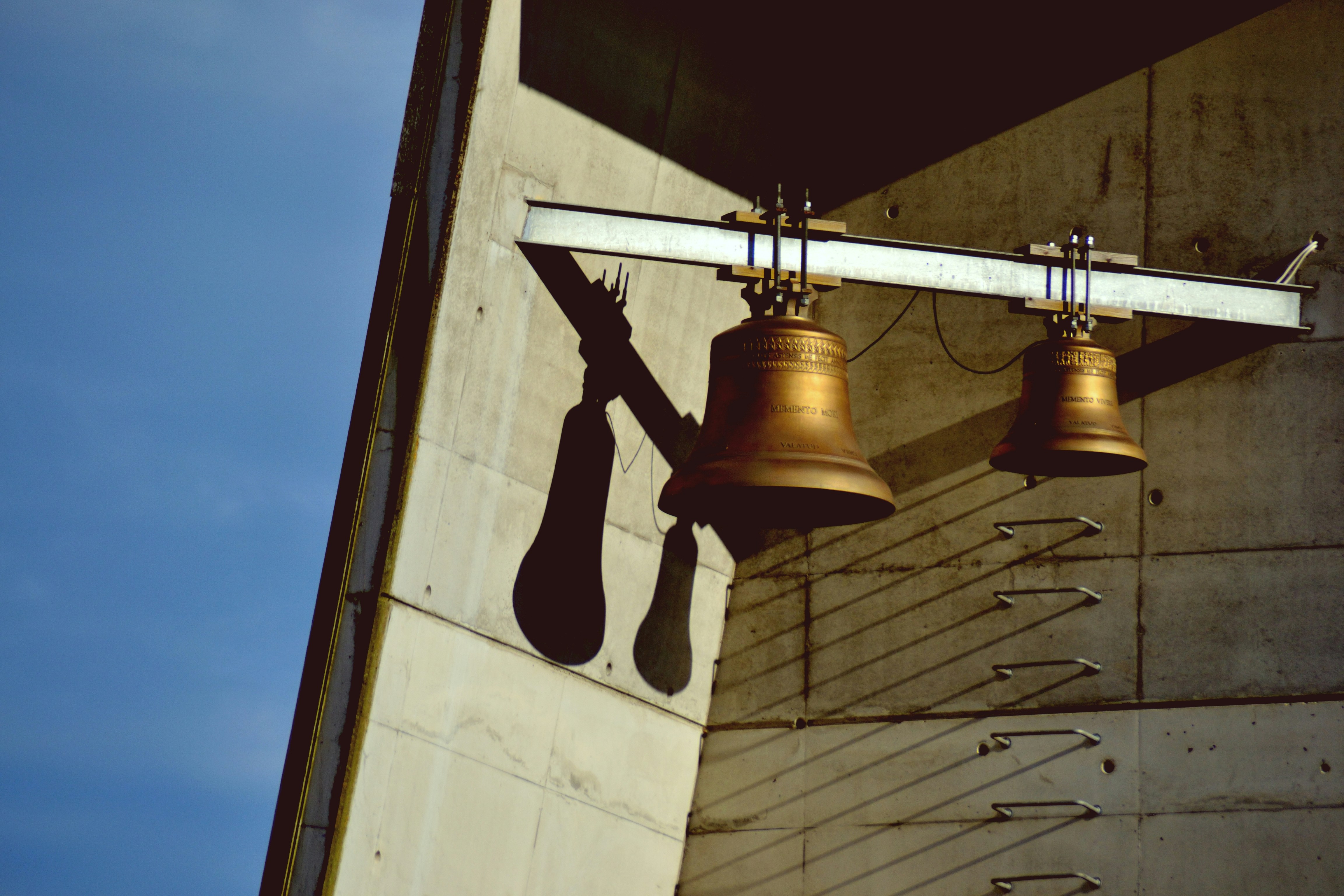 Bride of the Bell: Shadows and Steel on a Concrete Face