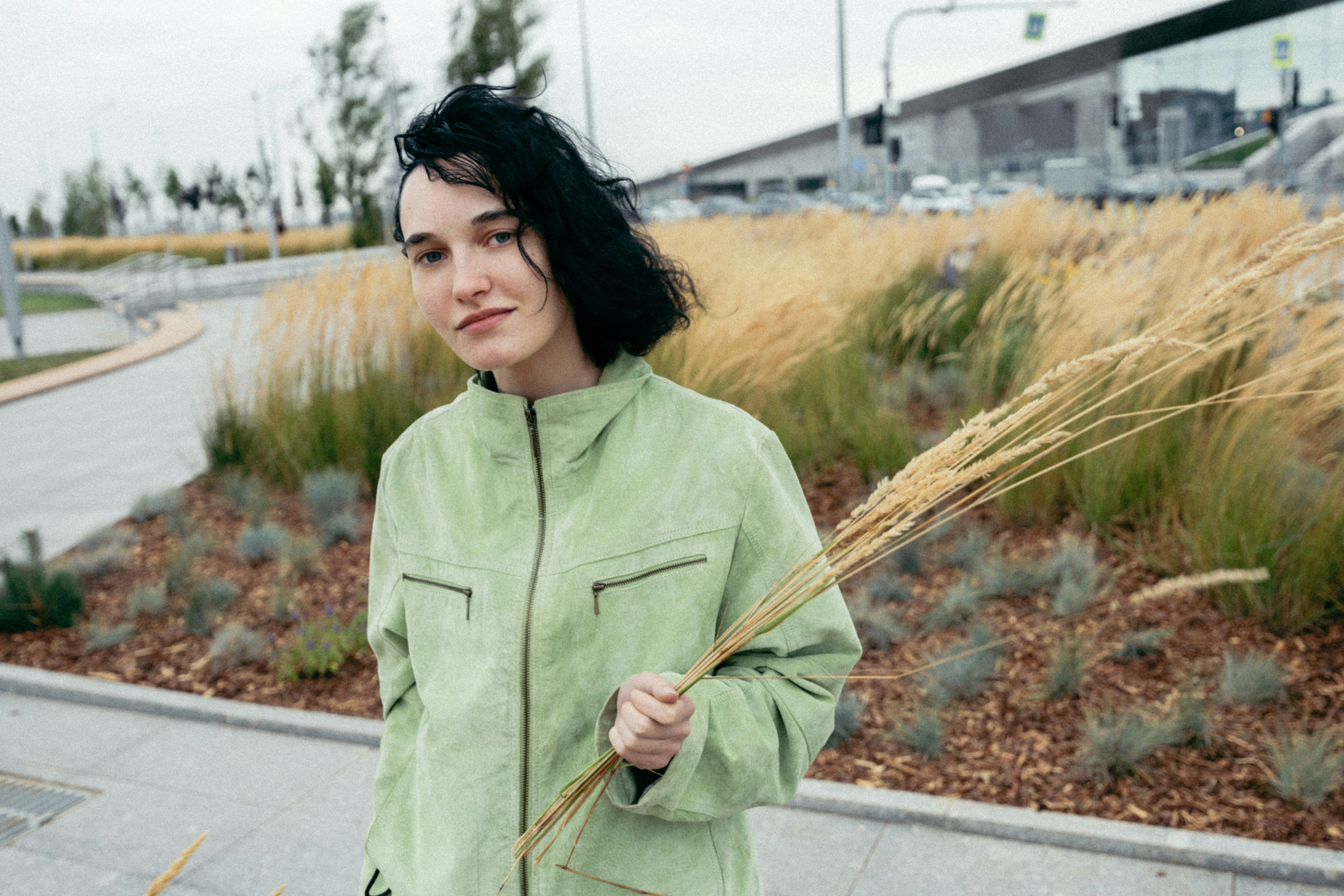 Green Jacket, Quiet Confidence: Portrait in a Windy Park