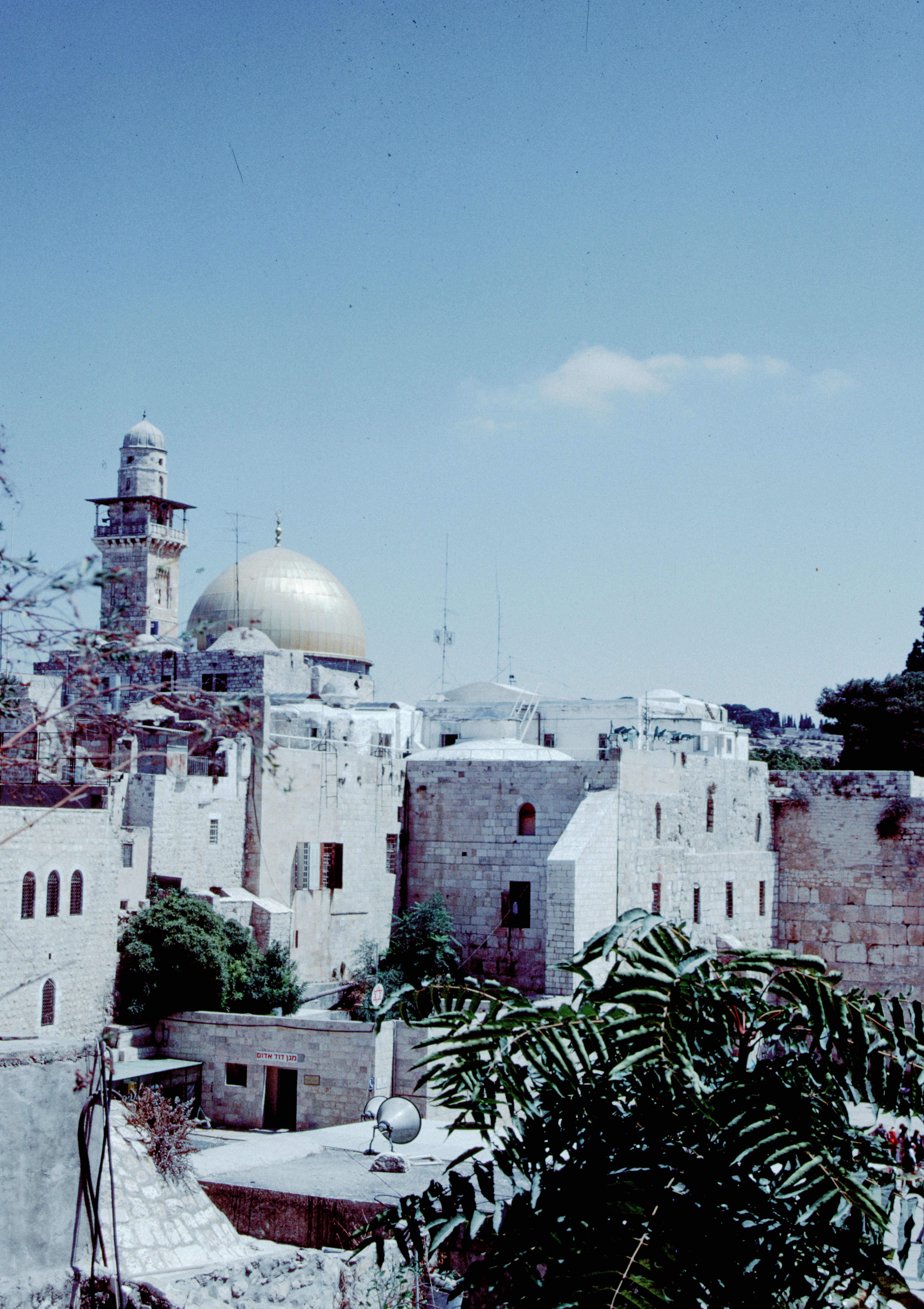 Dome and Minaret Over White Stone: An Old Cityscape Under a Clear Sky