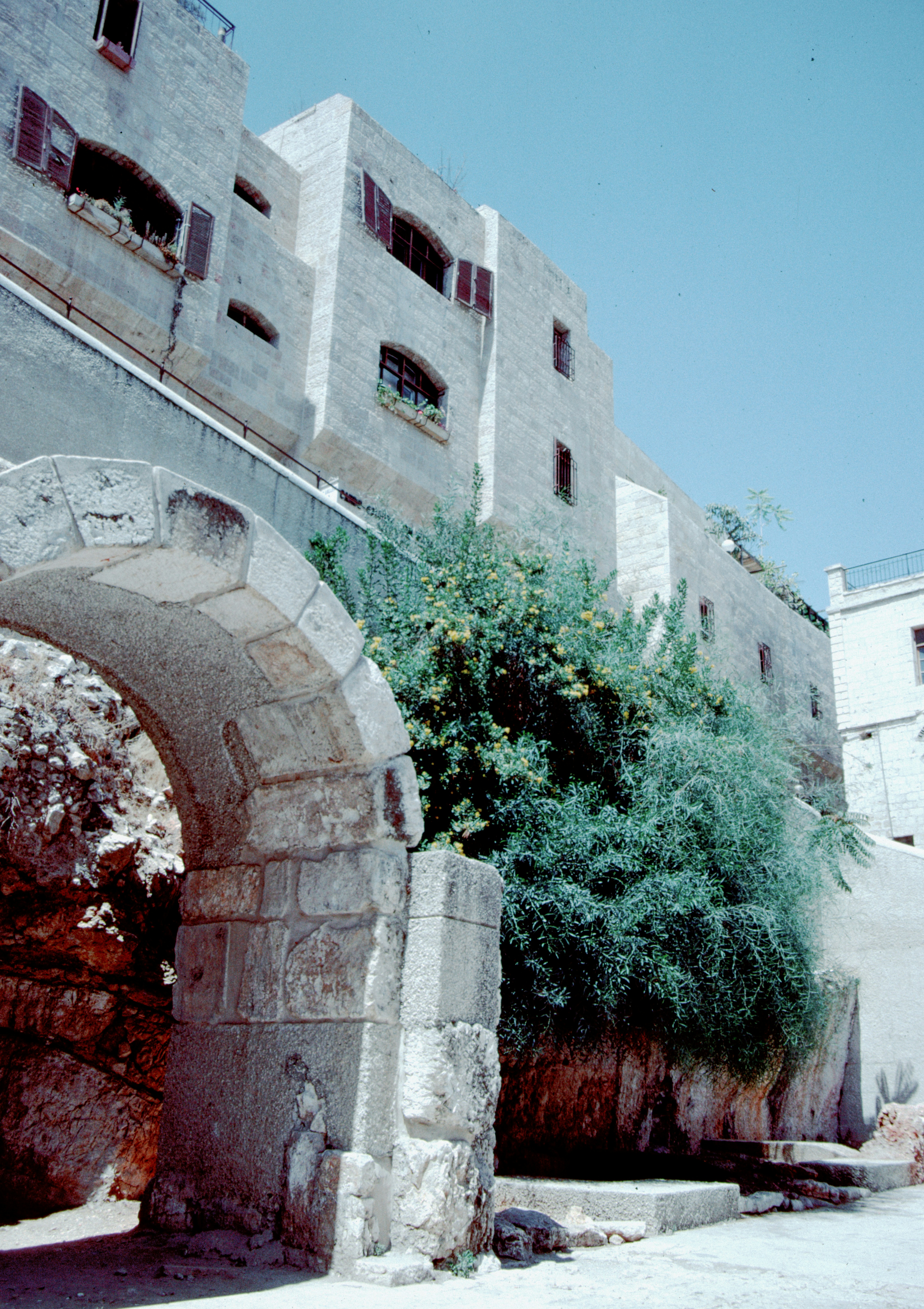 Stone Archway Framing a Sunlit Terrace