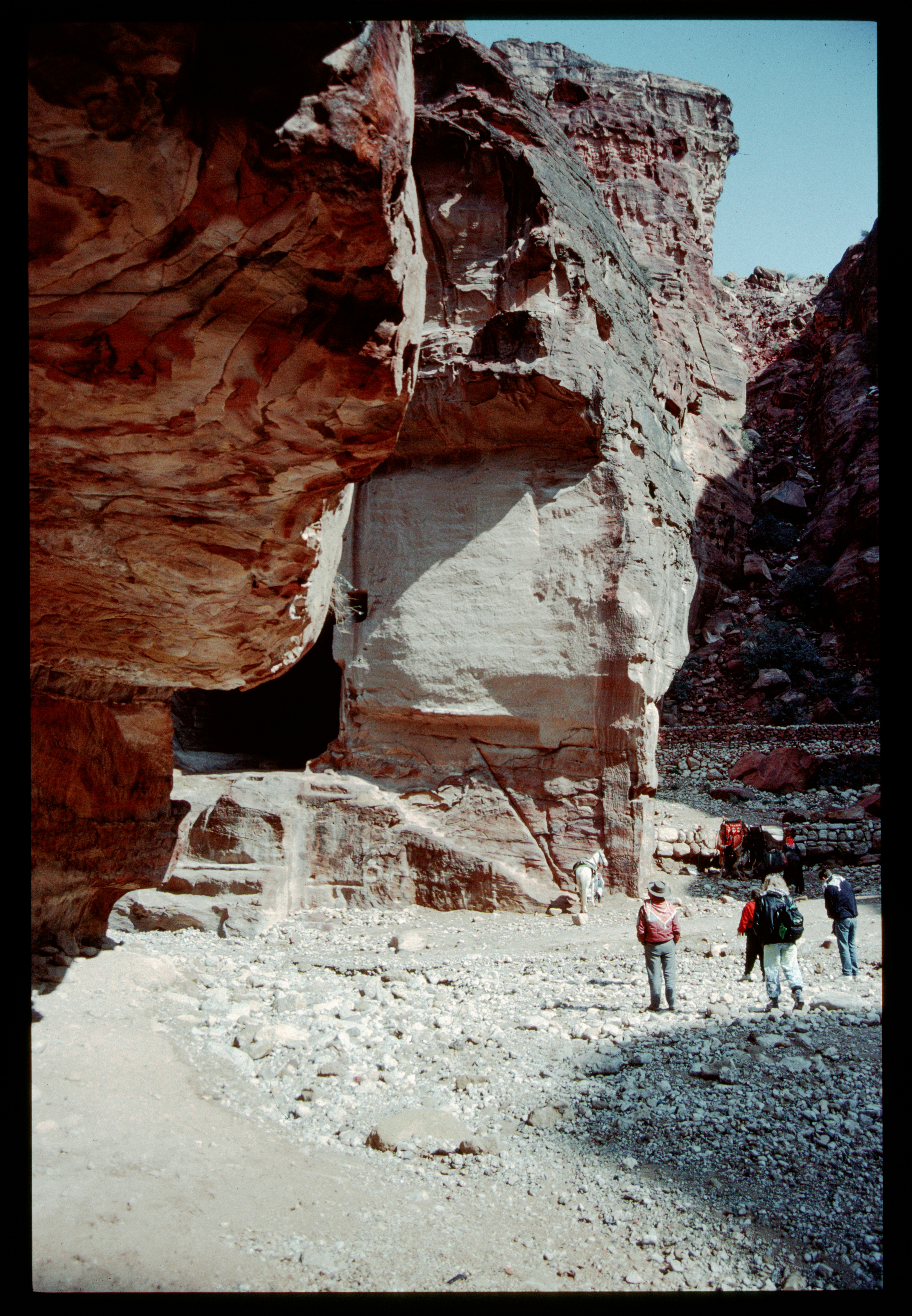 Trail into the Red Rock Shadow: Cliff Face and Climber Reach