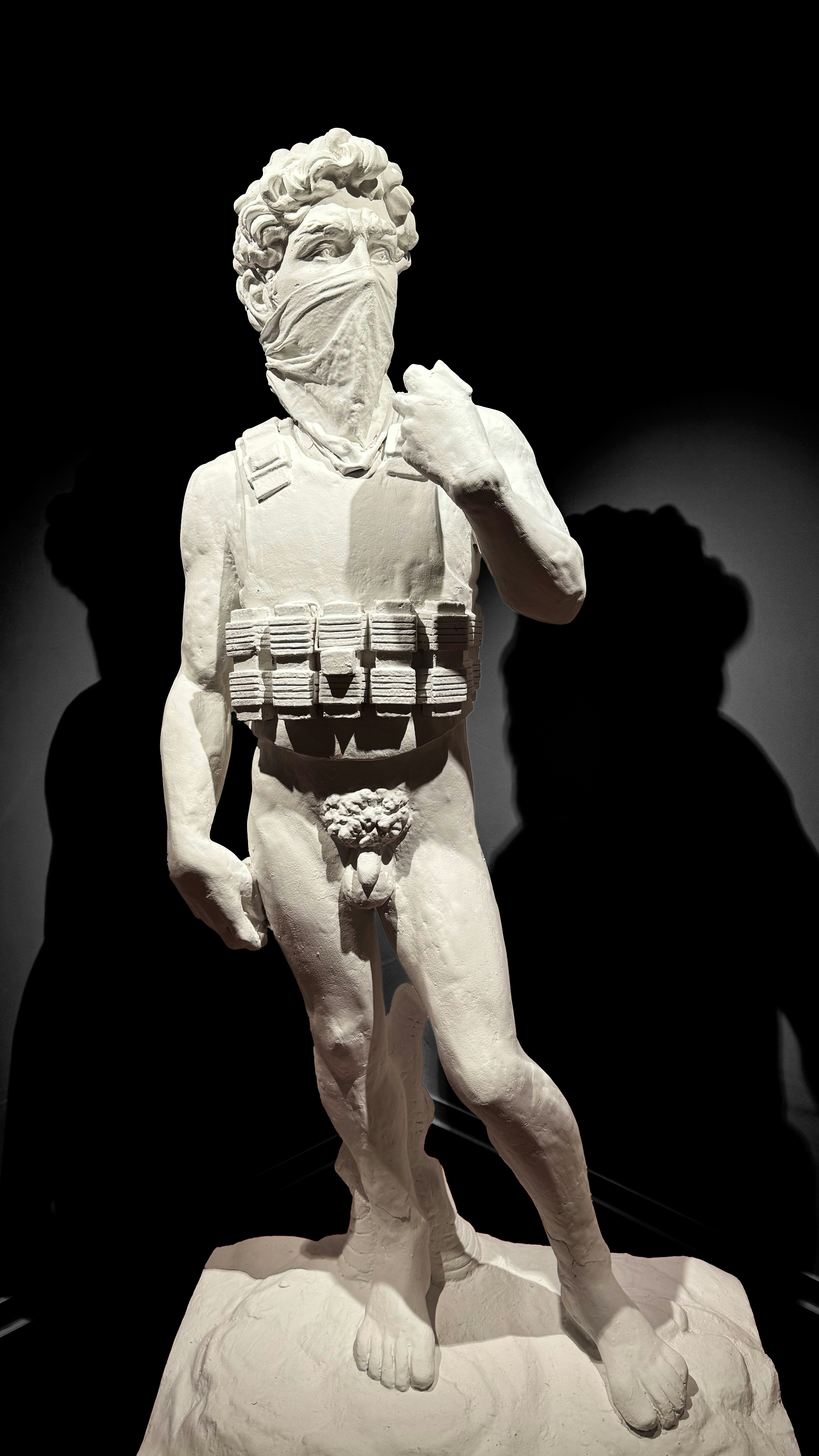 Masked Warrior Statue Under Spotlight
