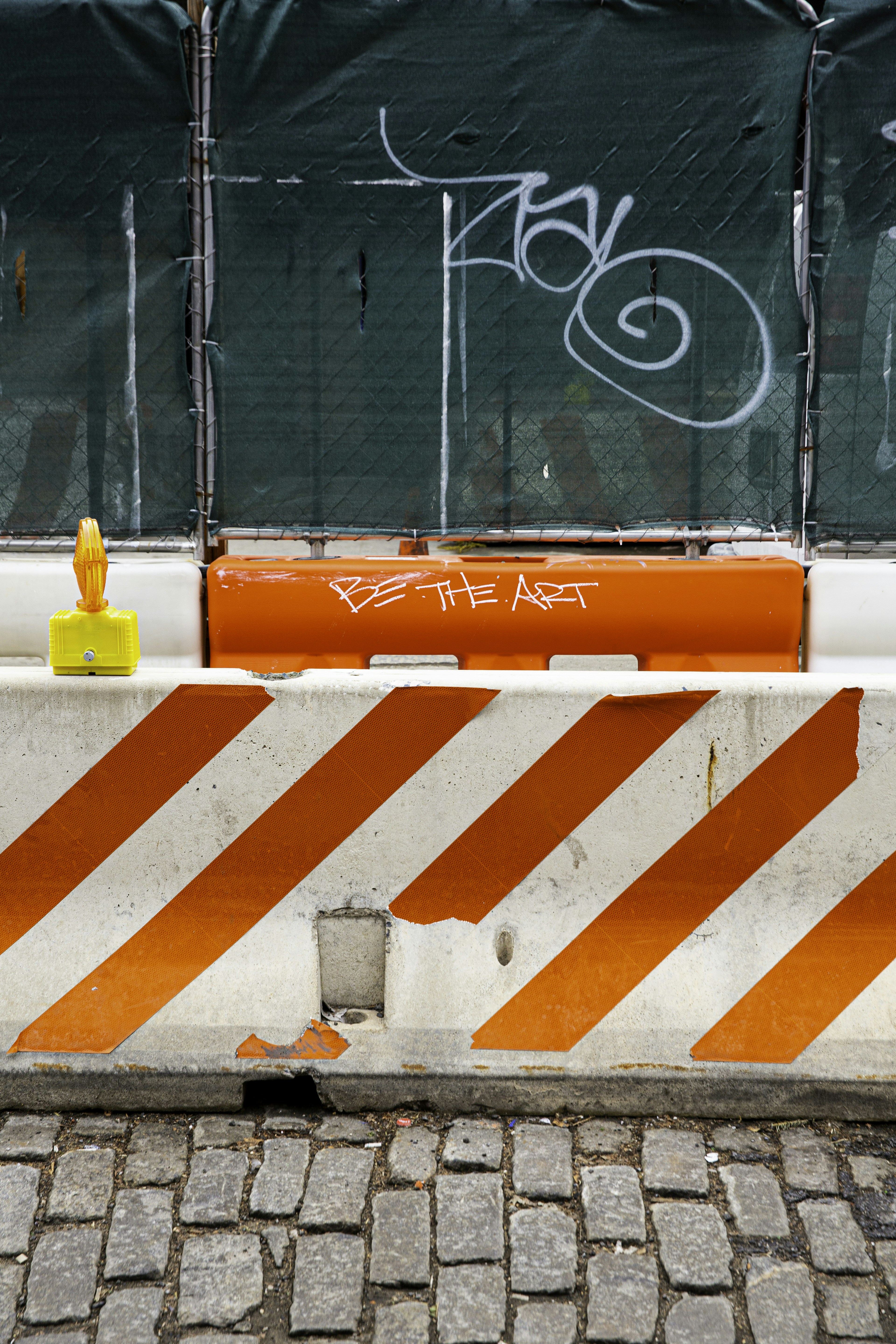 Concrete Crescent: A Barrier of Stripes and Graffiti