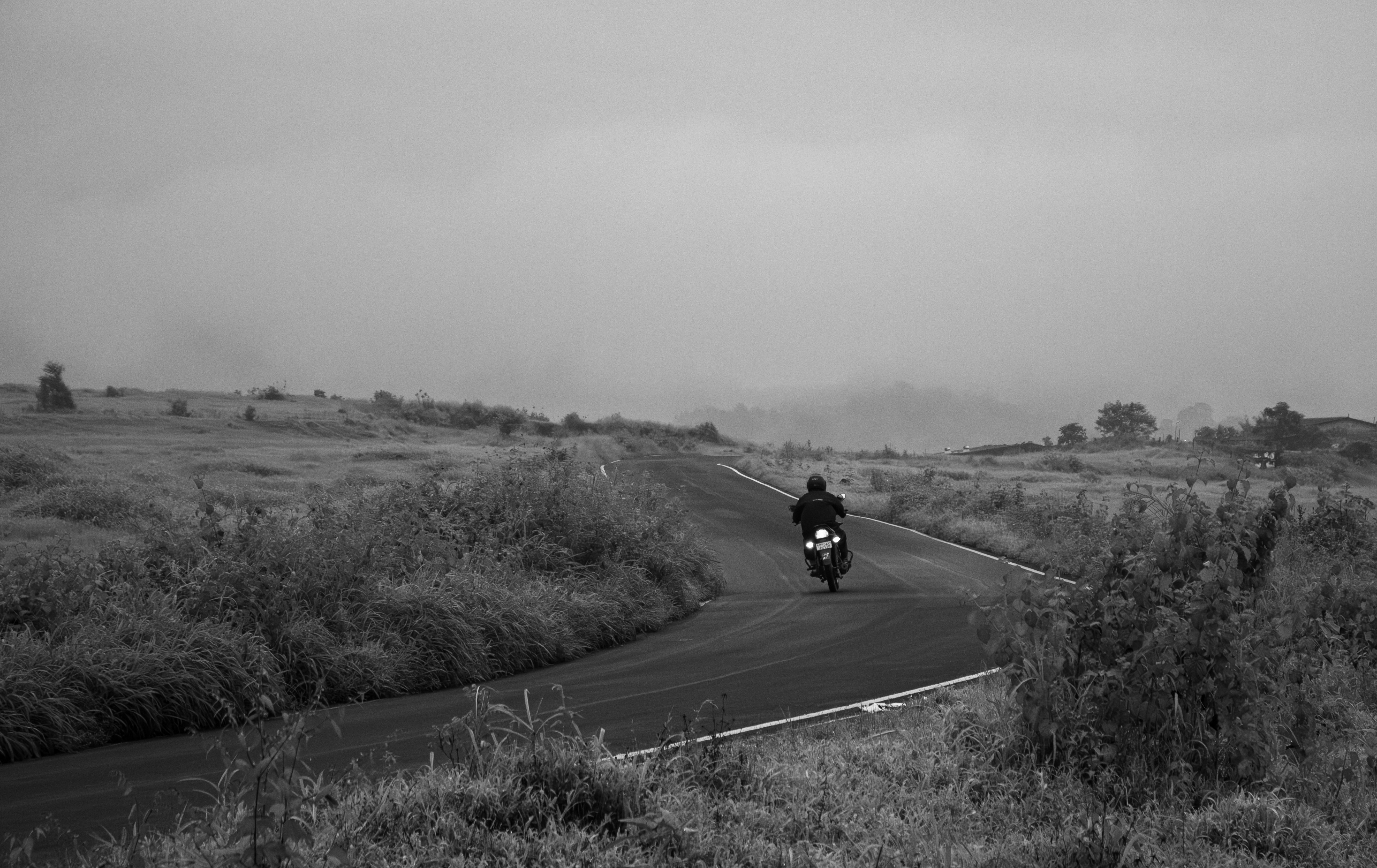 Desert Road Warrior: A Lone Rider Traverses a Curved Horizon