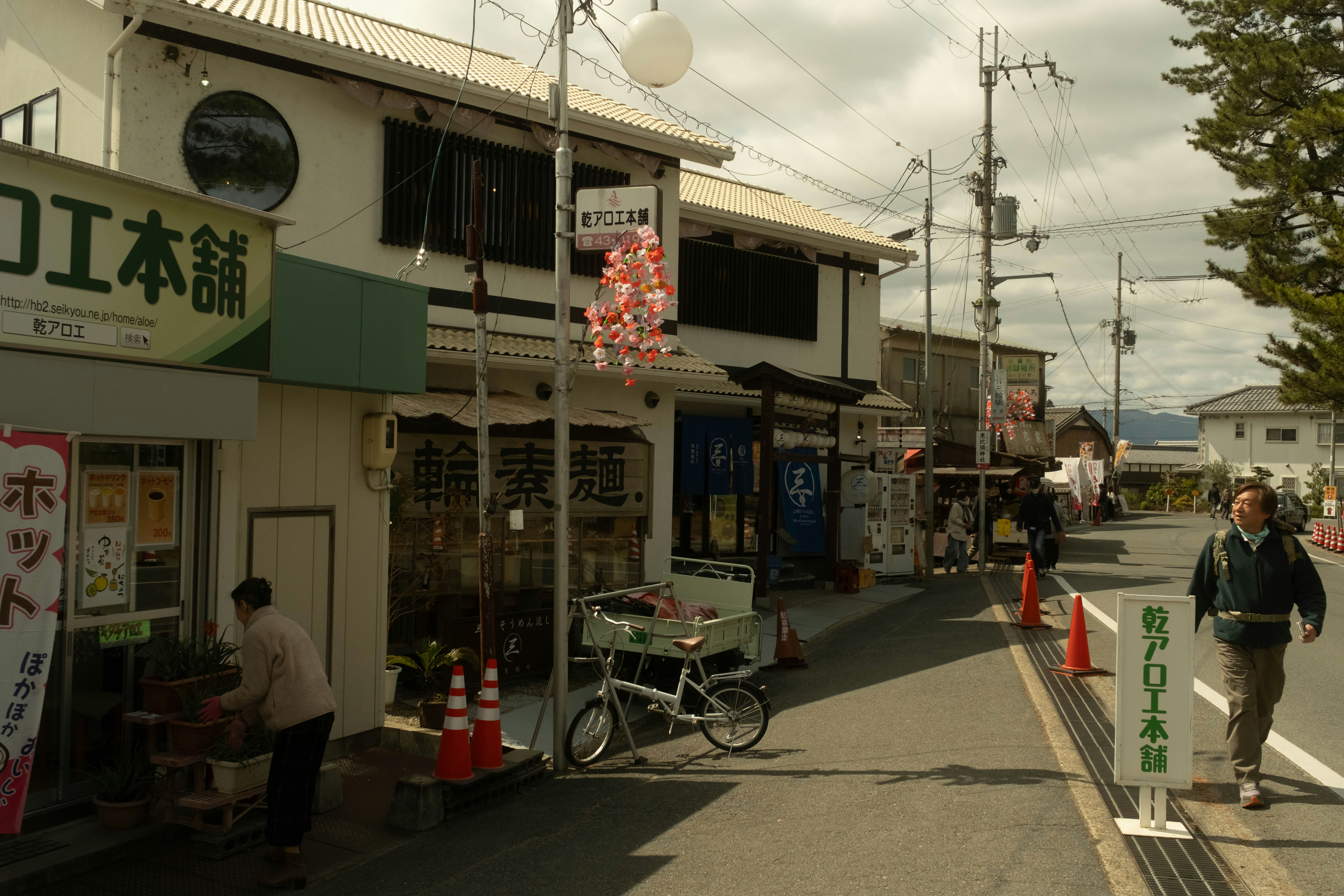Street with hanging lanterns and local shopfronts in a quiet Japanese town