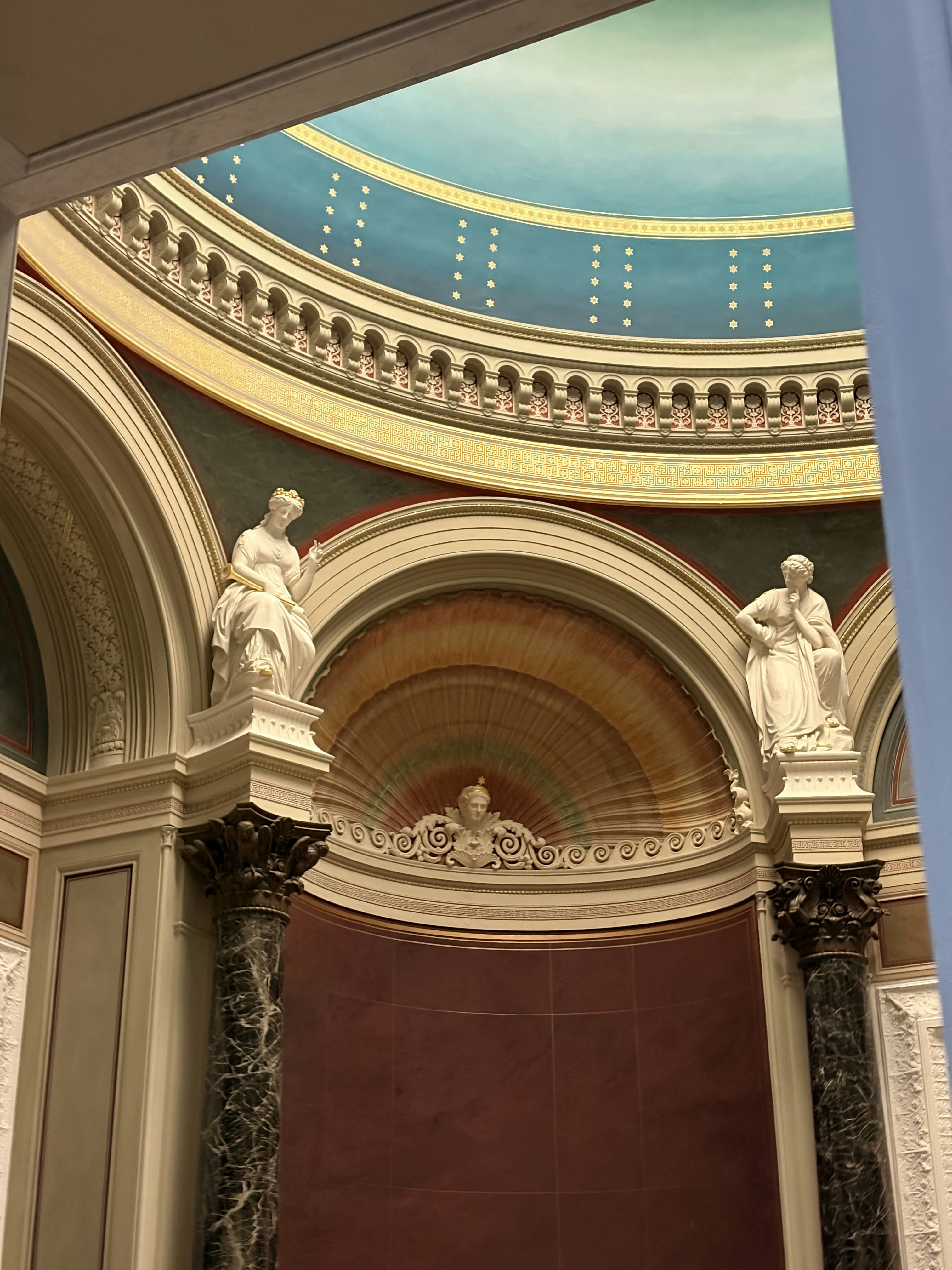 Domed Colonnade: Sculpted Statues Guard the Archway