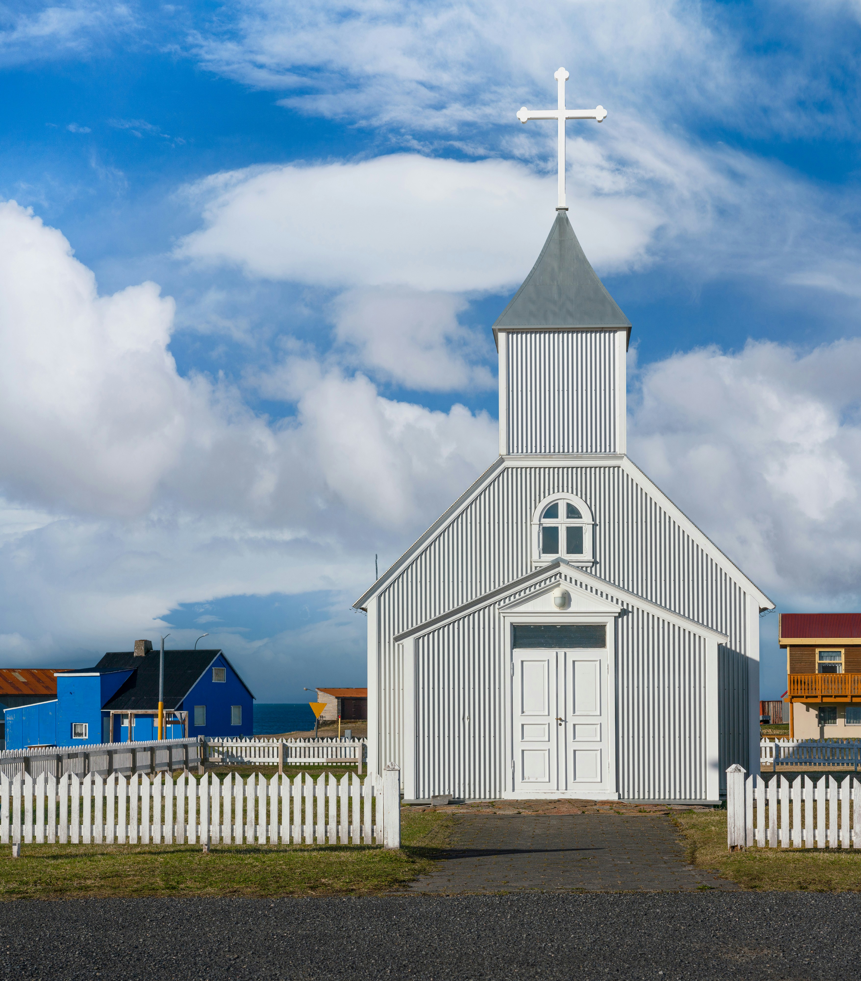 White Chapel at the Edge of a Colorful Coastal Village