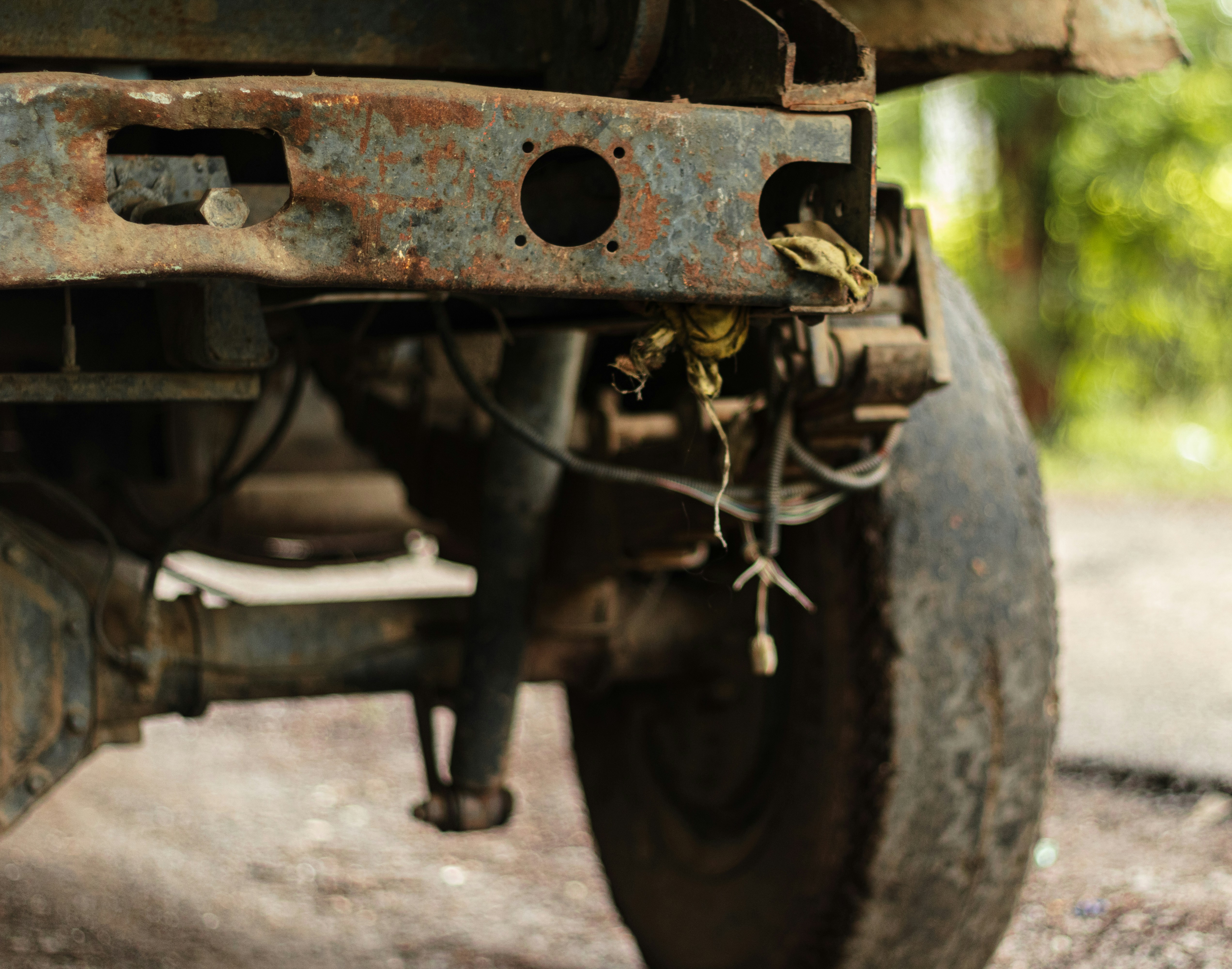 Rusting Wheelbase: Decay Beneath a Forgotten Vehicle