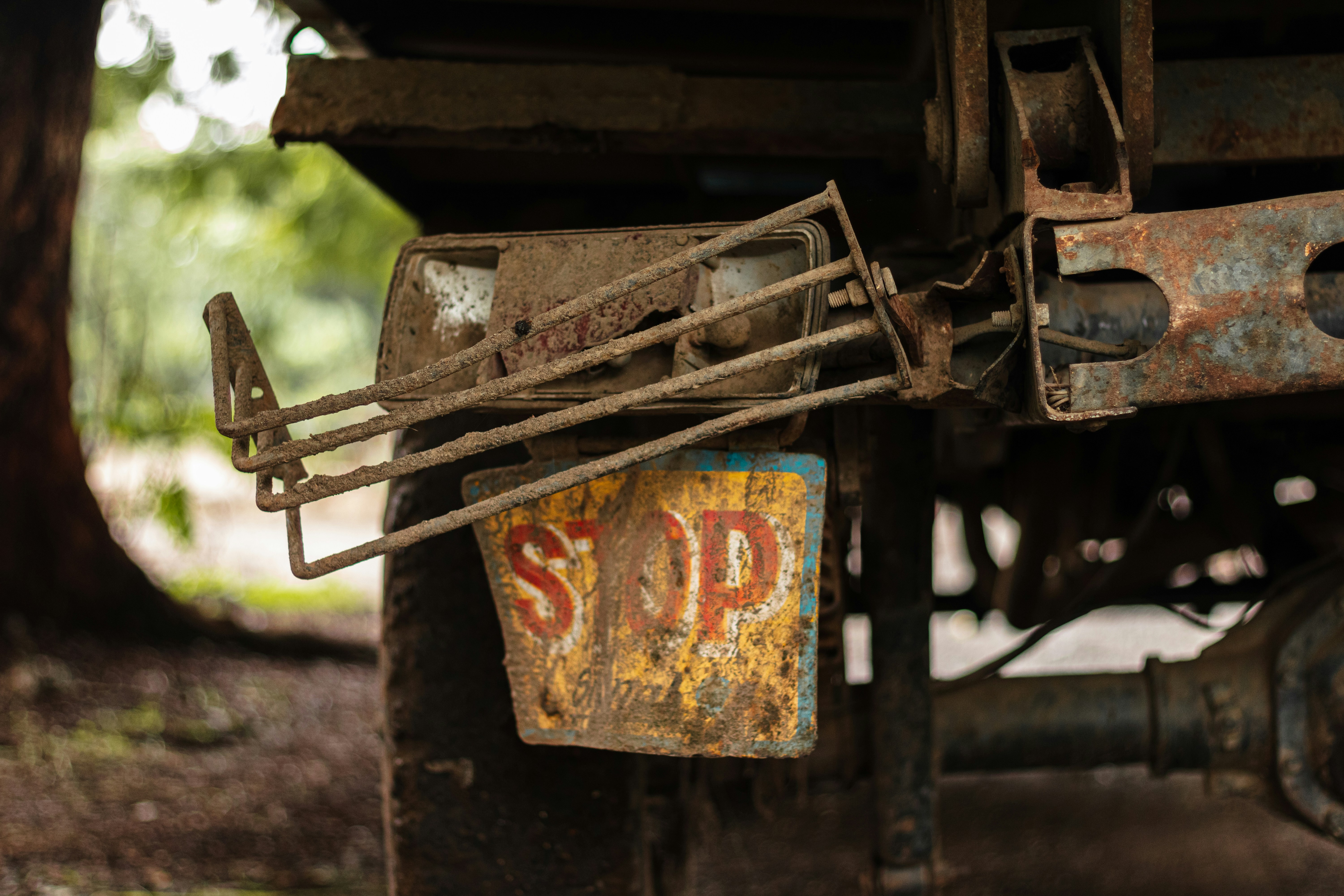 Weathered Stop Sign on a Rusted Farm Vehicle