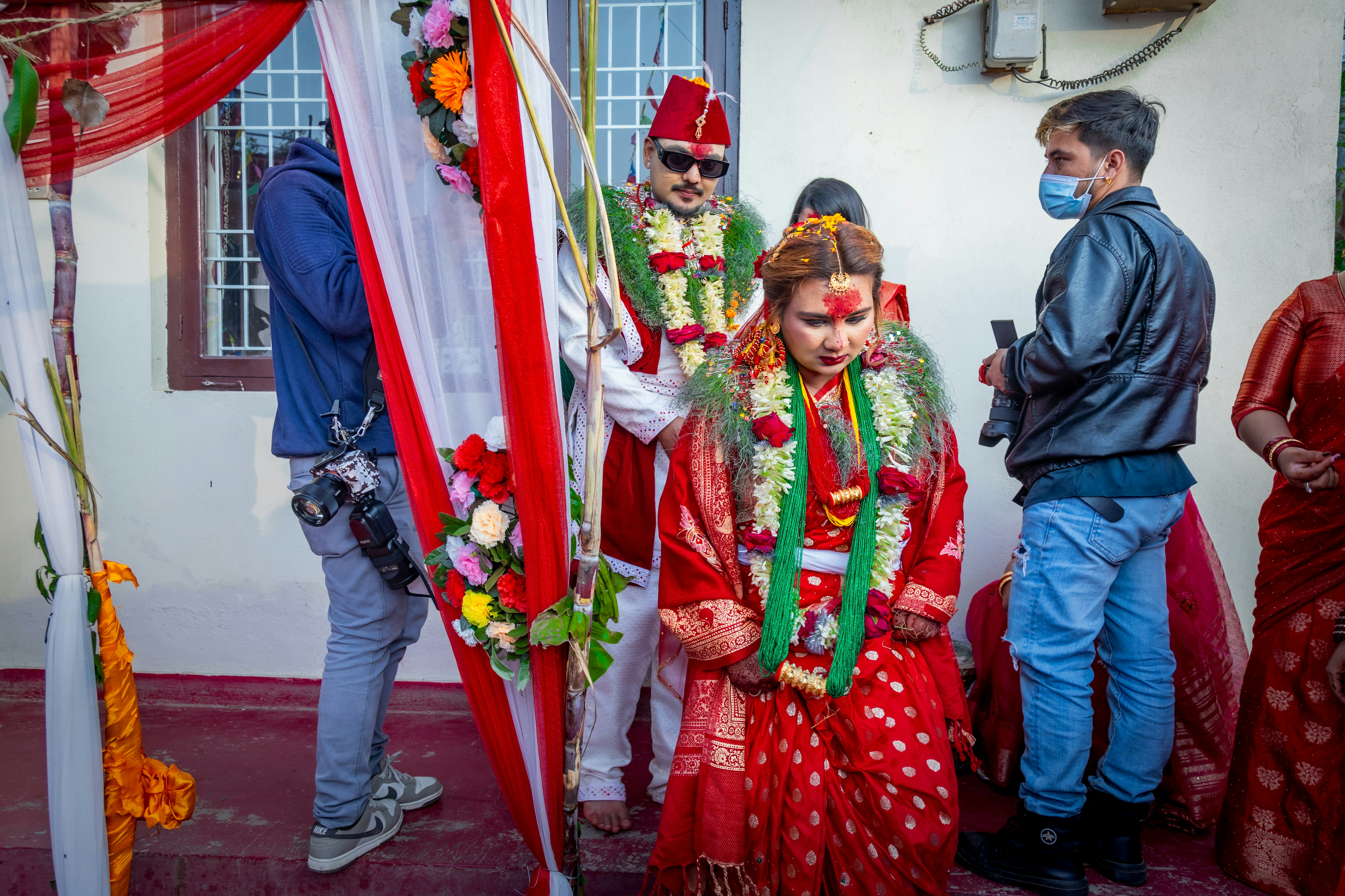 Bride in Crimson: Veil of Traditions at the Doorway