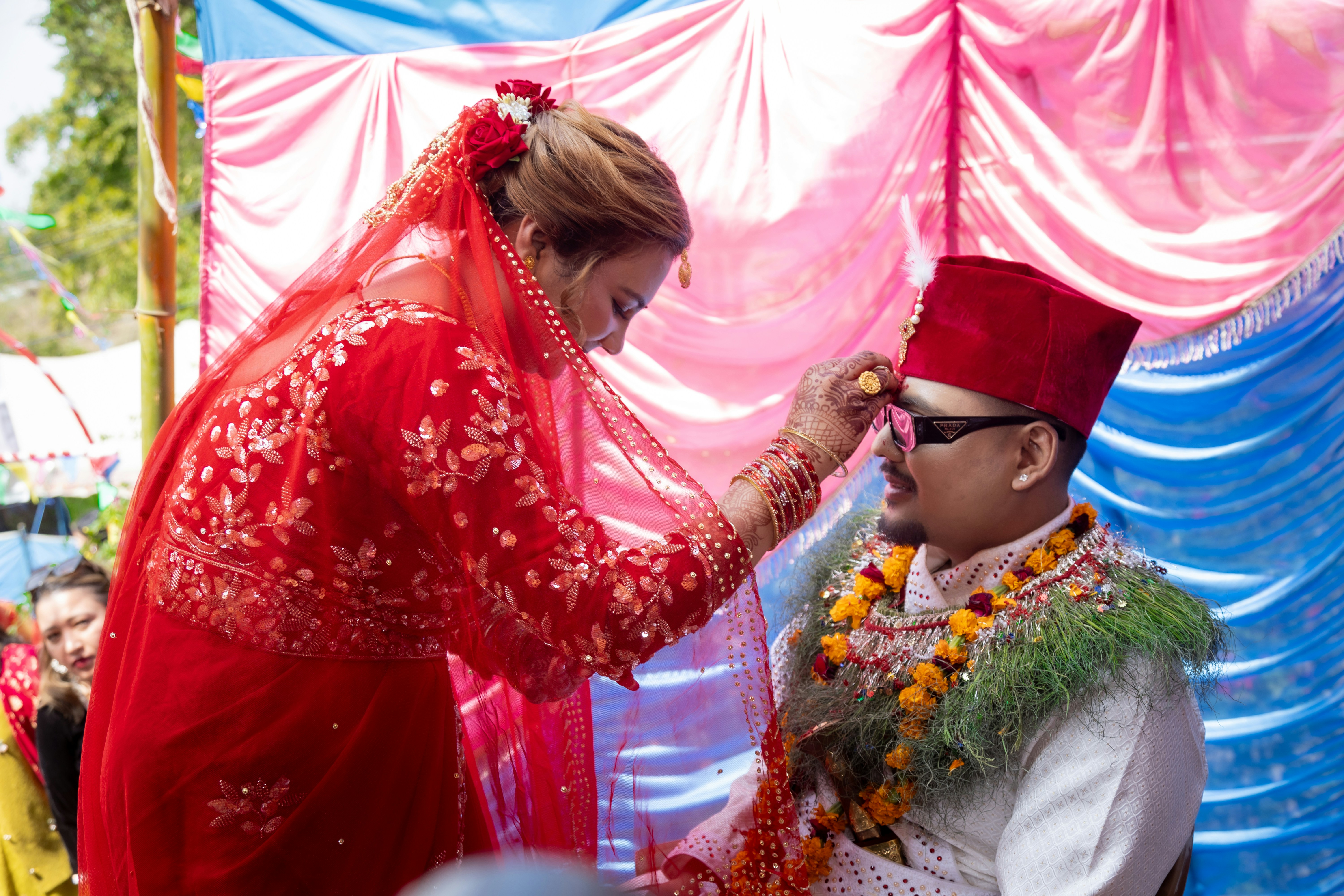 A Bride Adjusts the Groom’s Turban in a Vivid Hindu Nuptial Moment