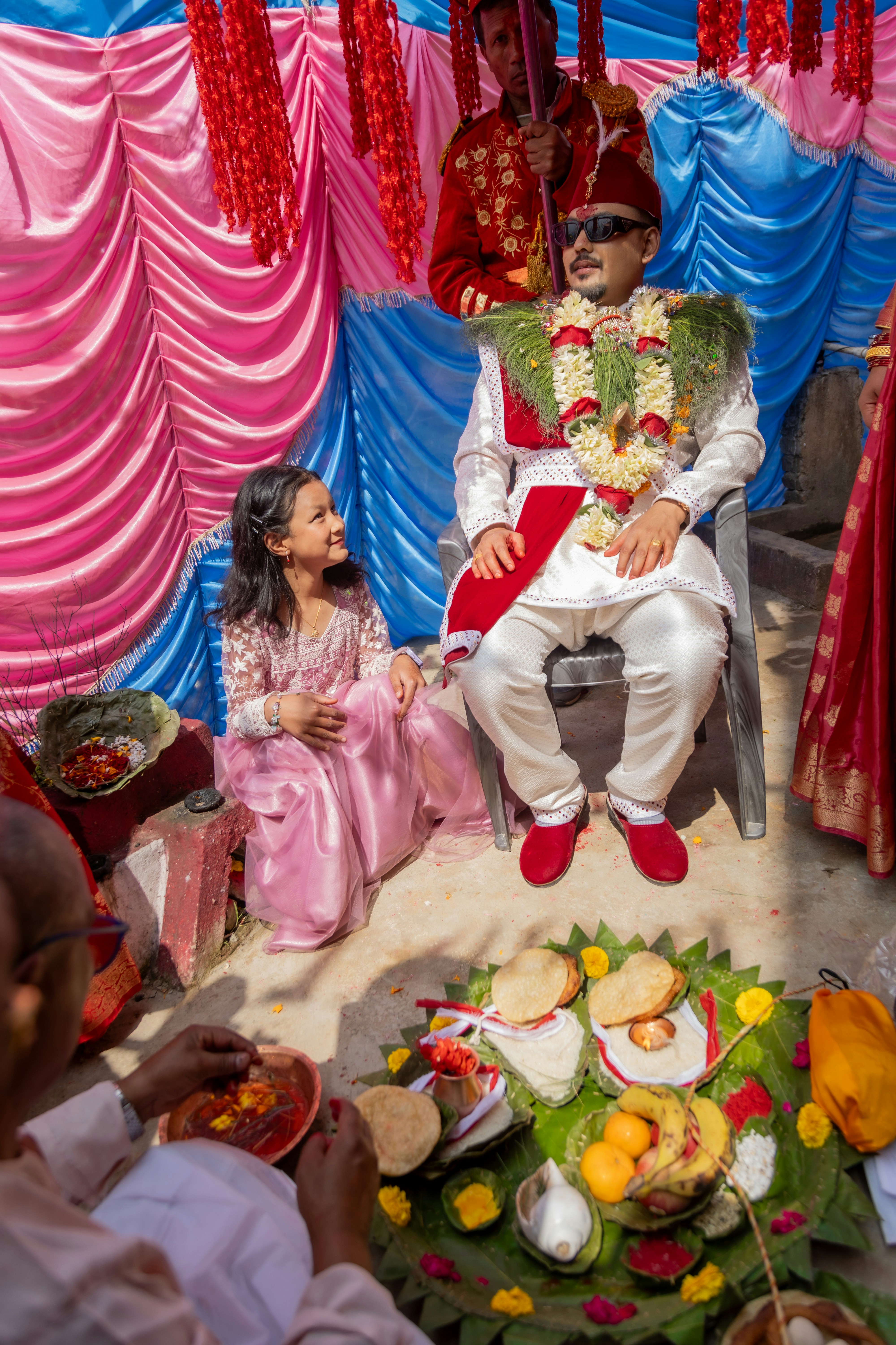 Garlanded Groom in Ceremony Under Festive Drapes