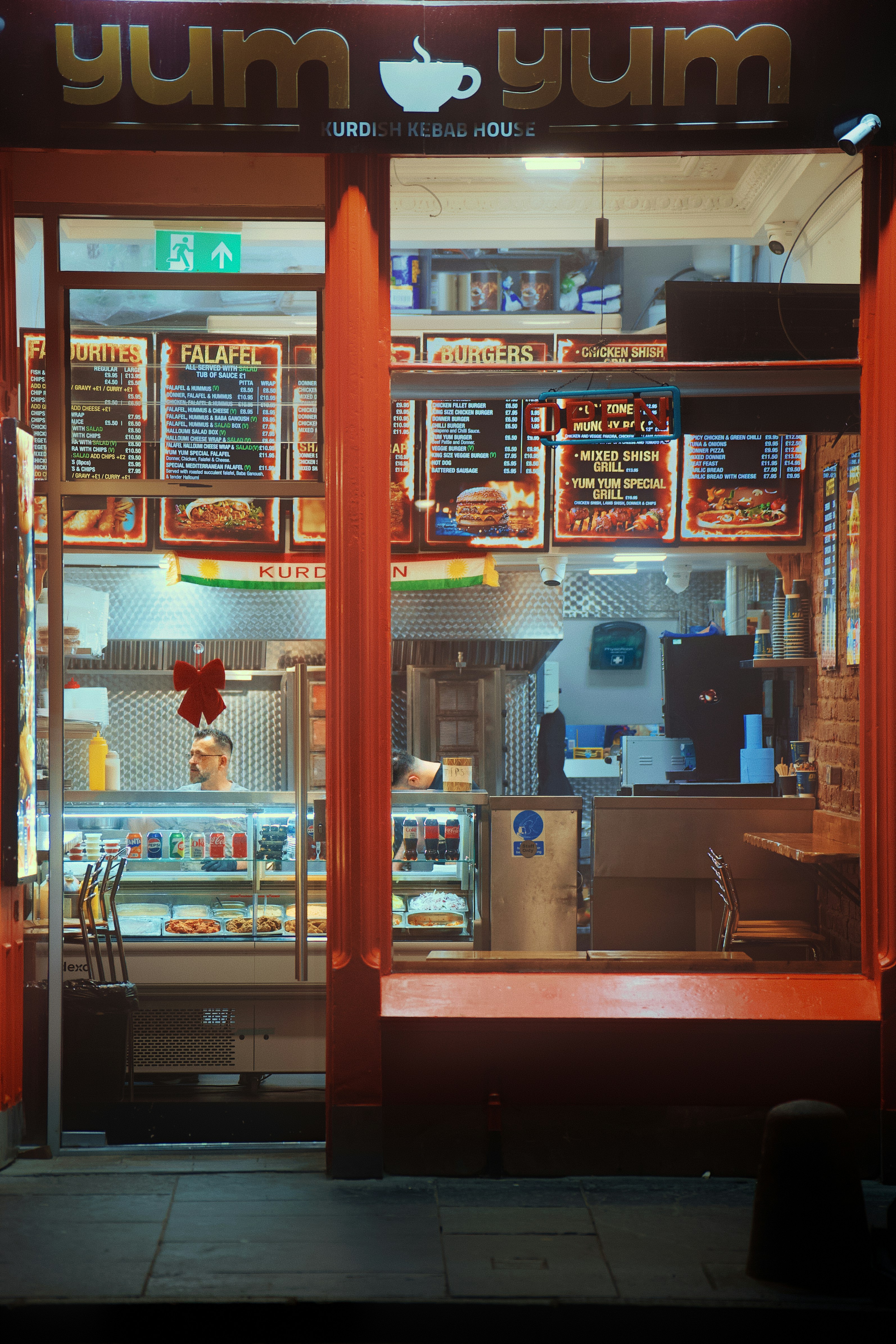 Yum Sign, Night Kitchen: A Neon-Flooded Kebap Stand Through Glass