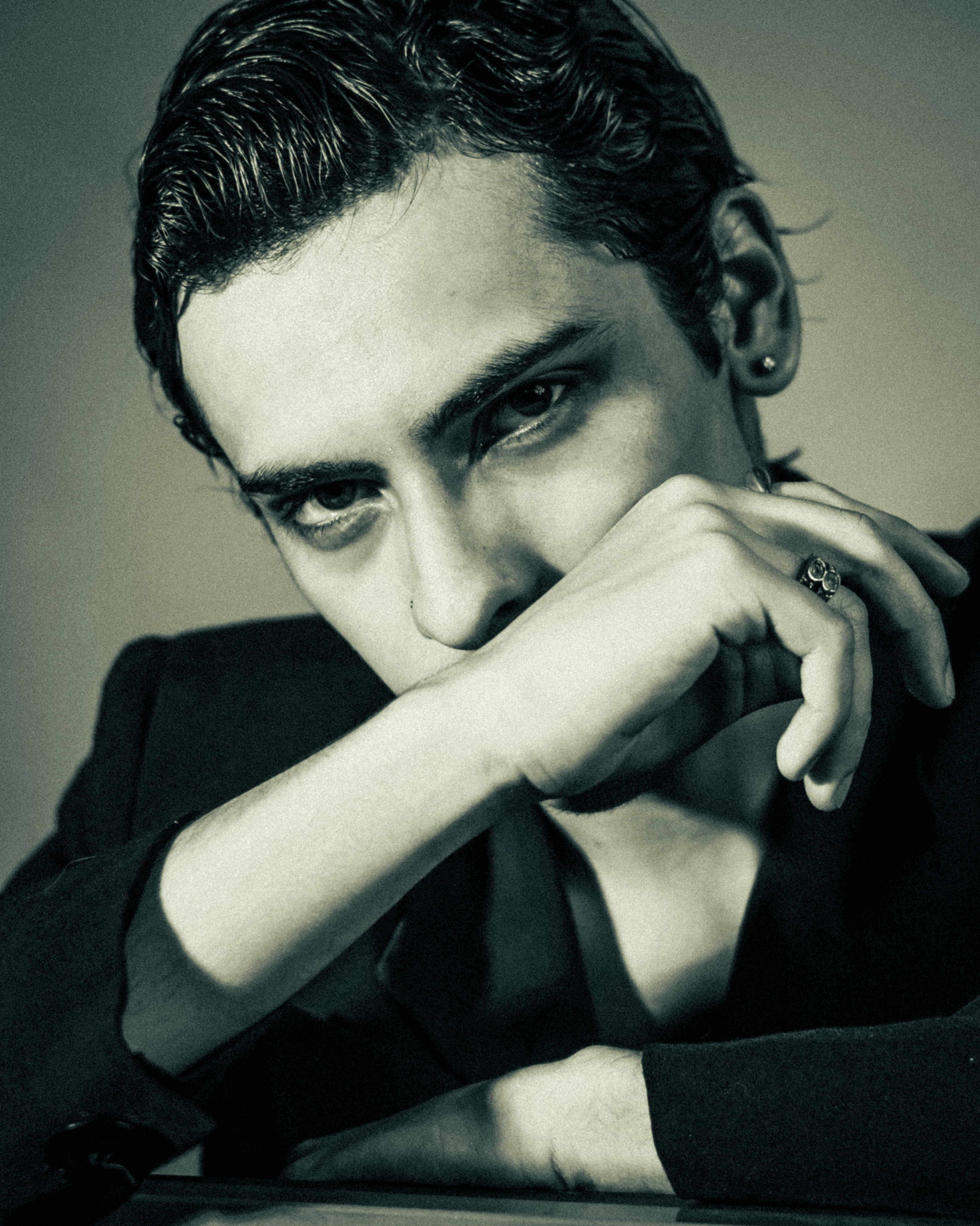 Shadowed Gaze: A Quiet Moment Behind the Hand