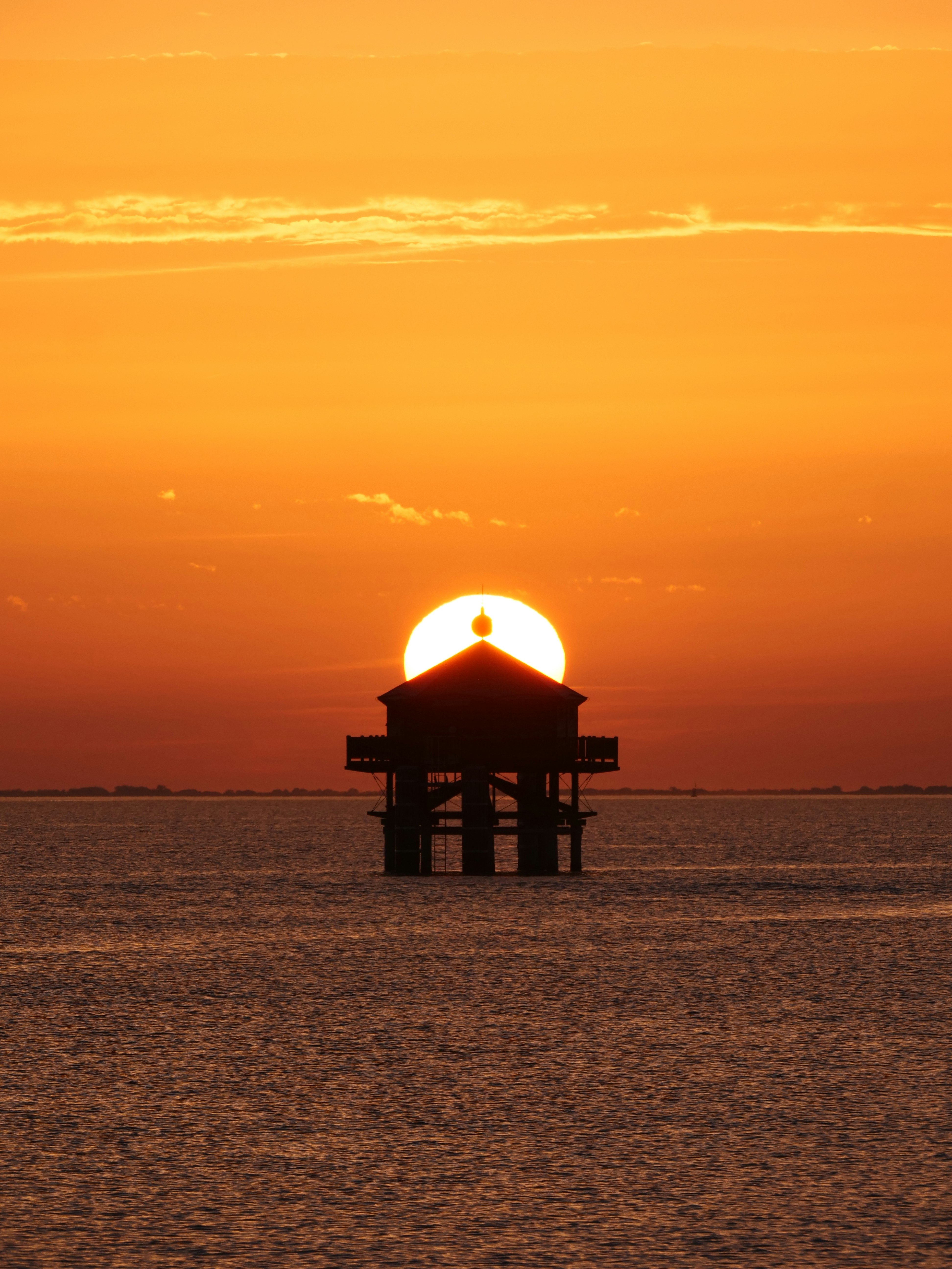 Sun-Bird Pier: Sunset Silhouette Over Calm Seas