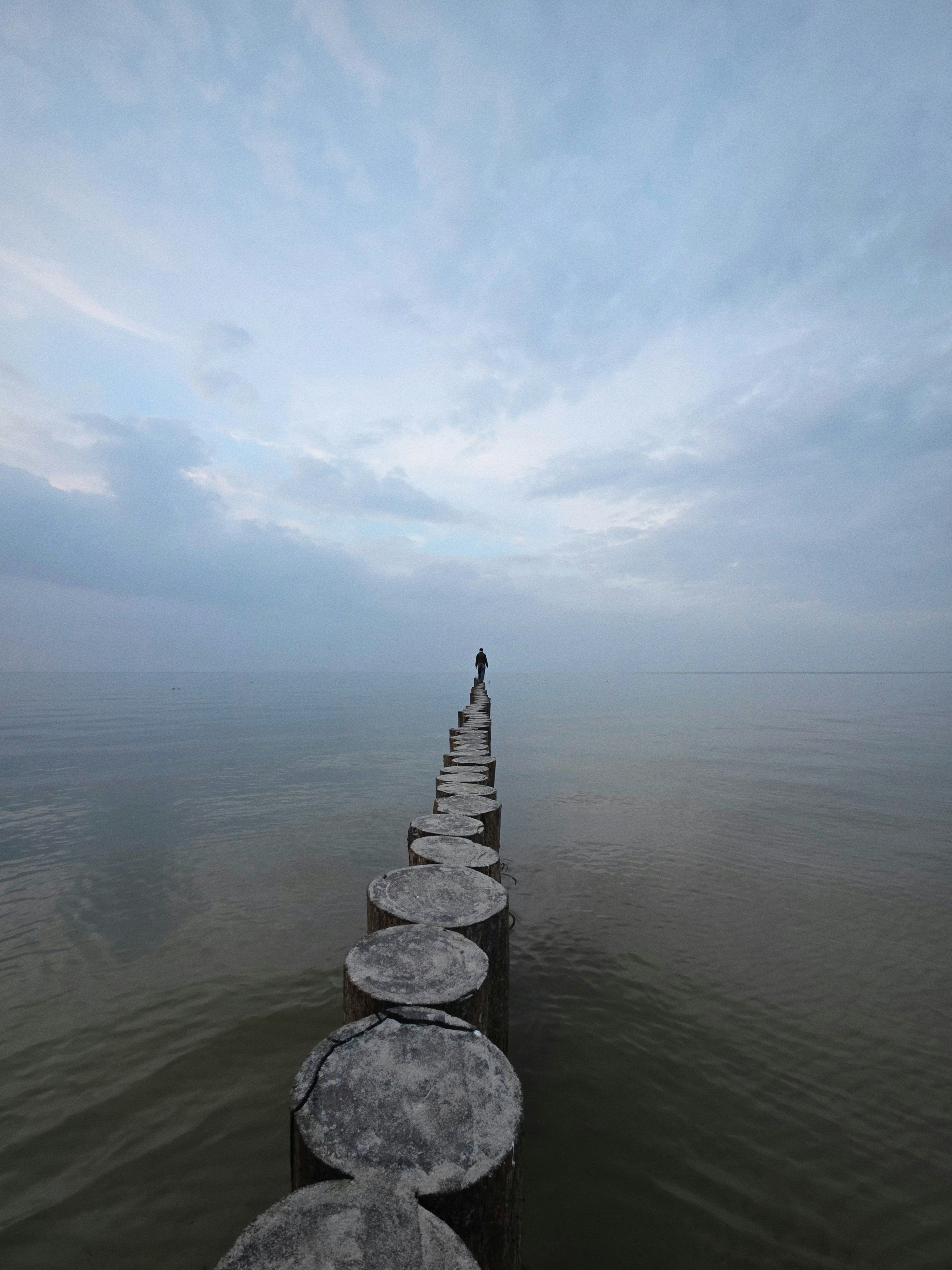 Pier to the Horizon: Lonely Posts Reaching the Sky