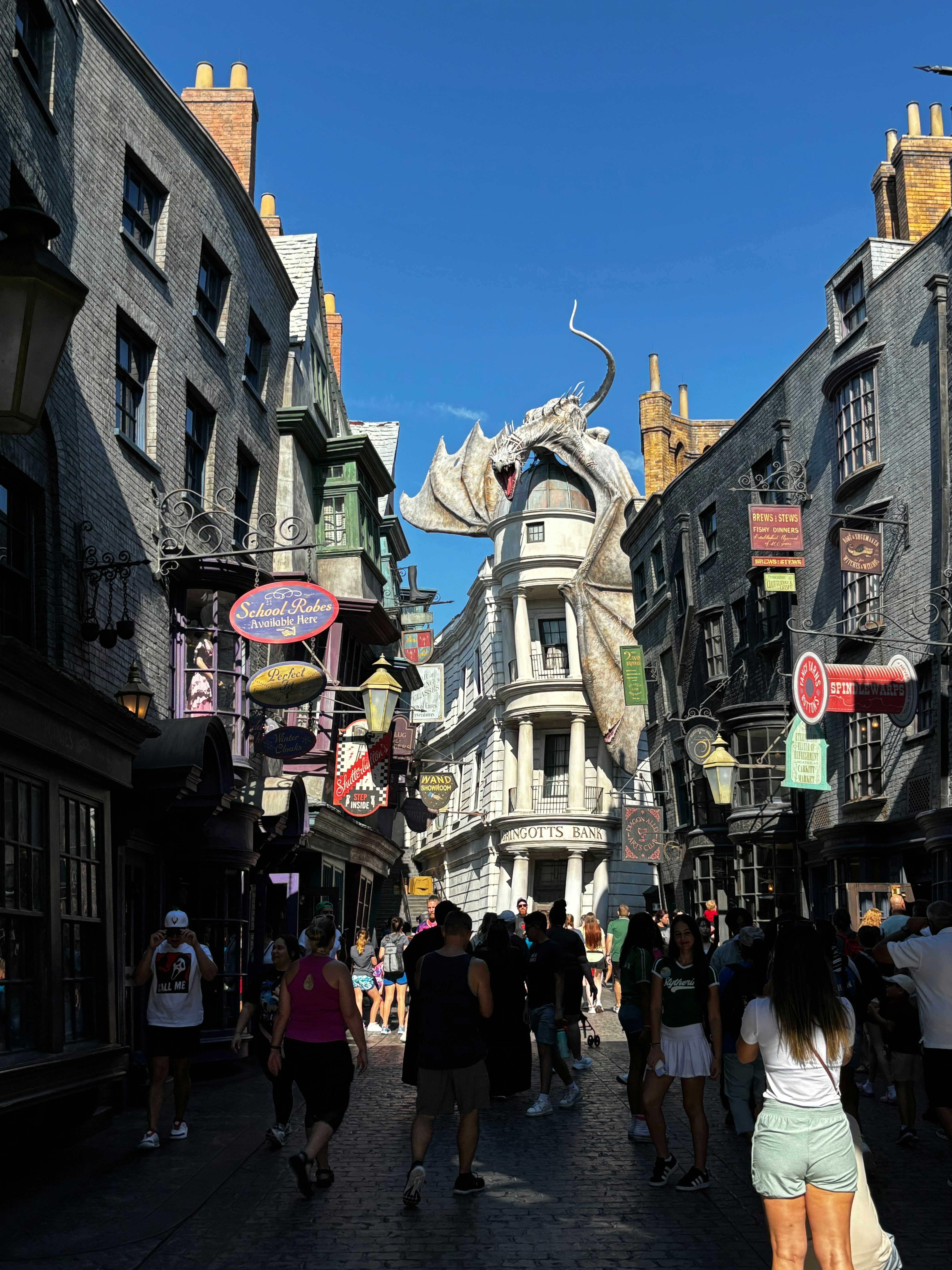 Dragon atop Gotham-style street towers over a bustling cobblestone avenue