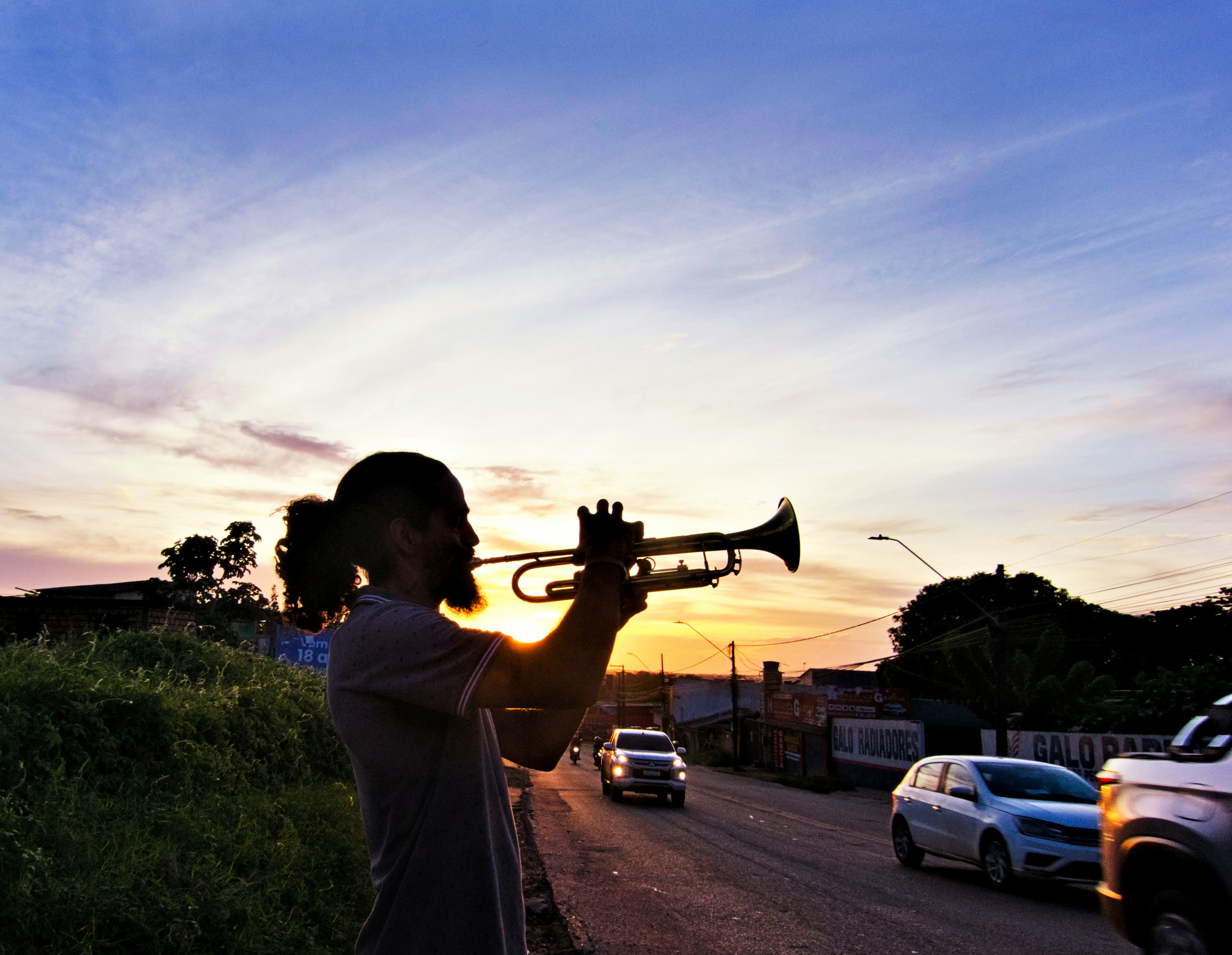 Silhouette in the Sunset: A Hornful Moment on the Street