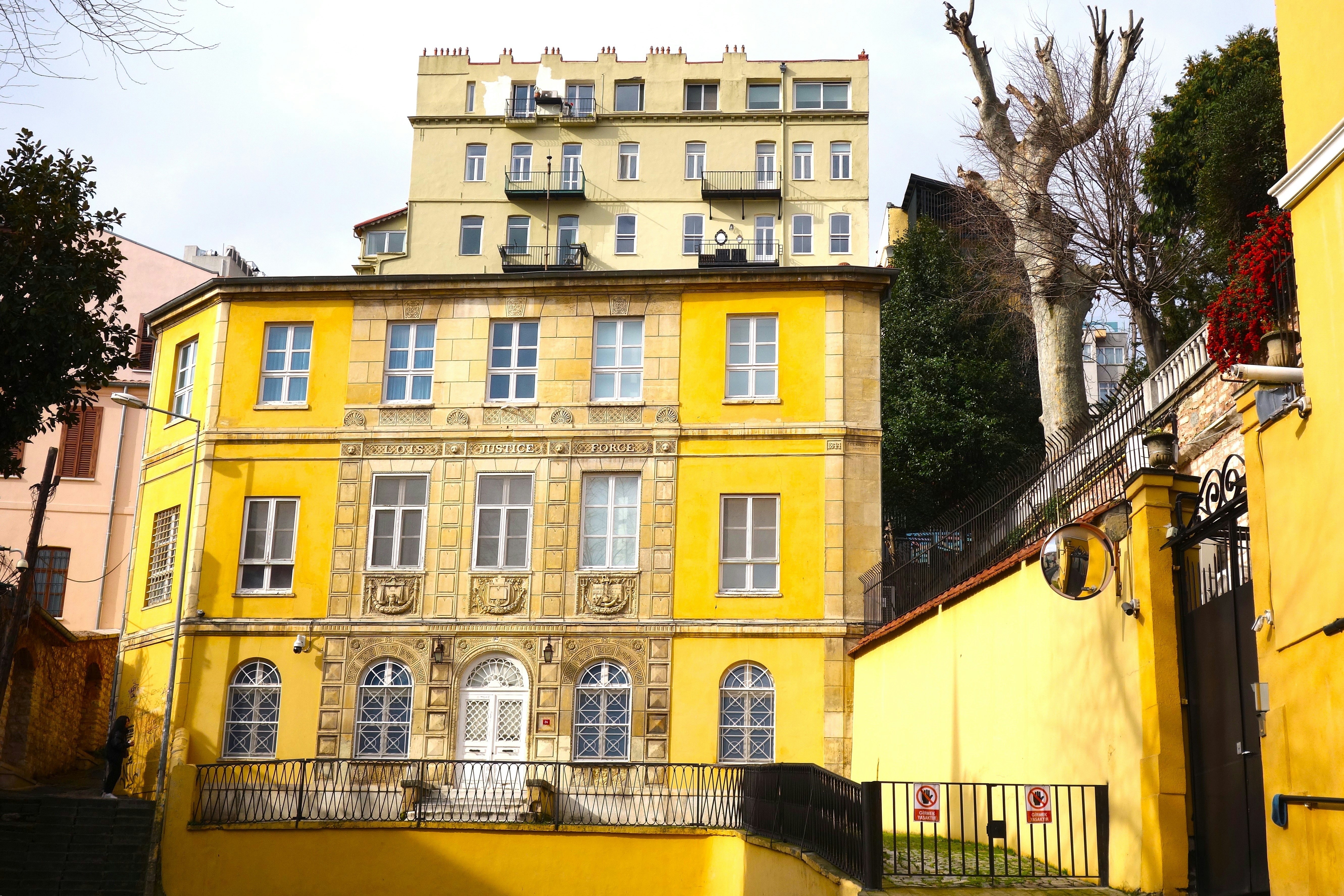 Sunlit Yellow Facade: A Romantic Staircase to the City