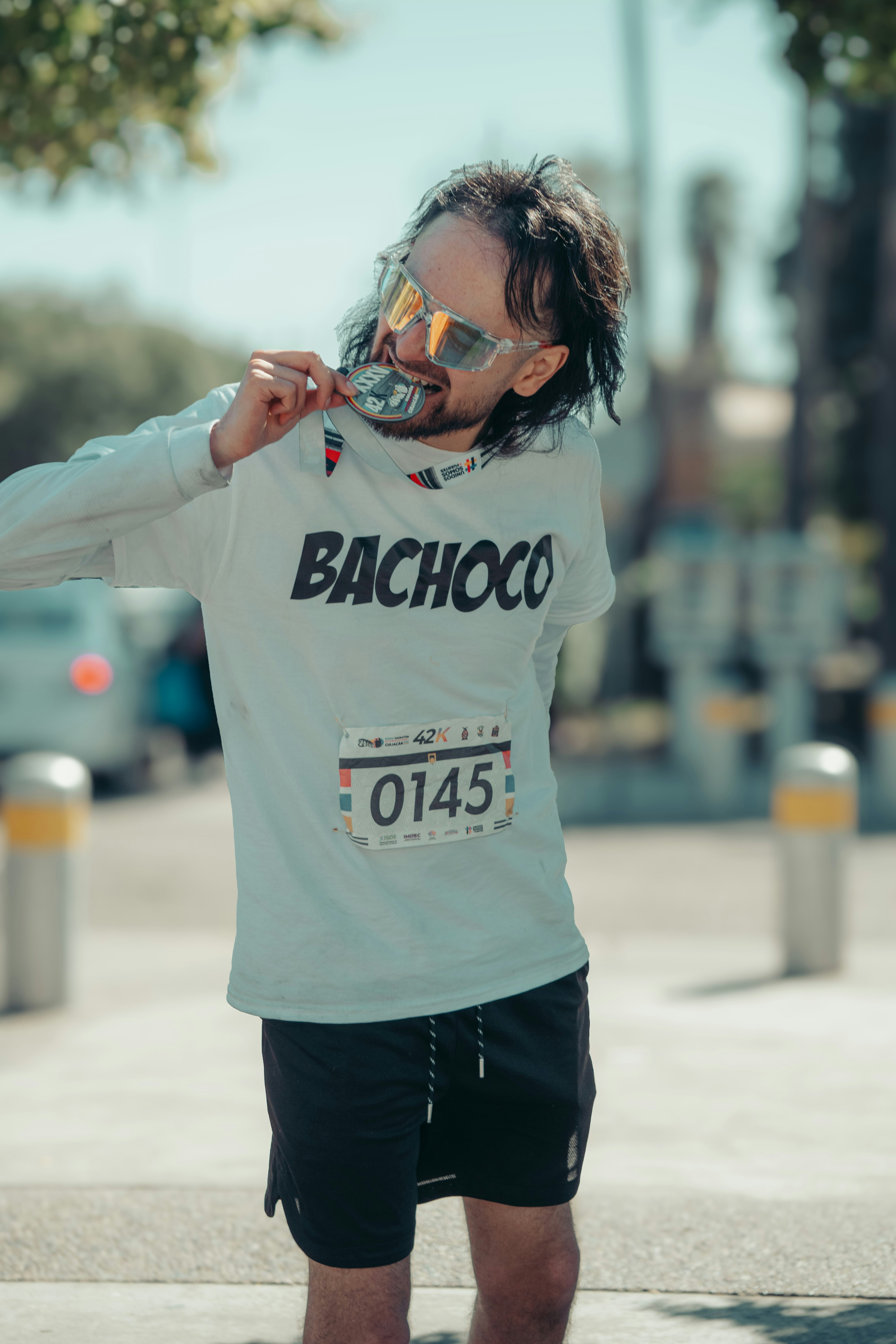 Selfie with a racer’s grin: a runner mid-cheer wears a BACHOC logo tee