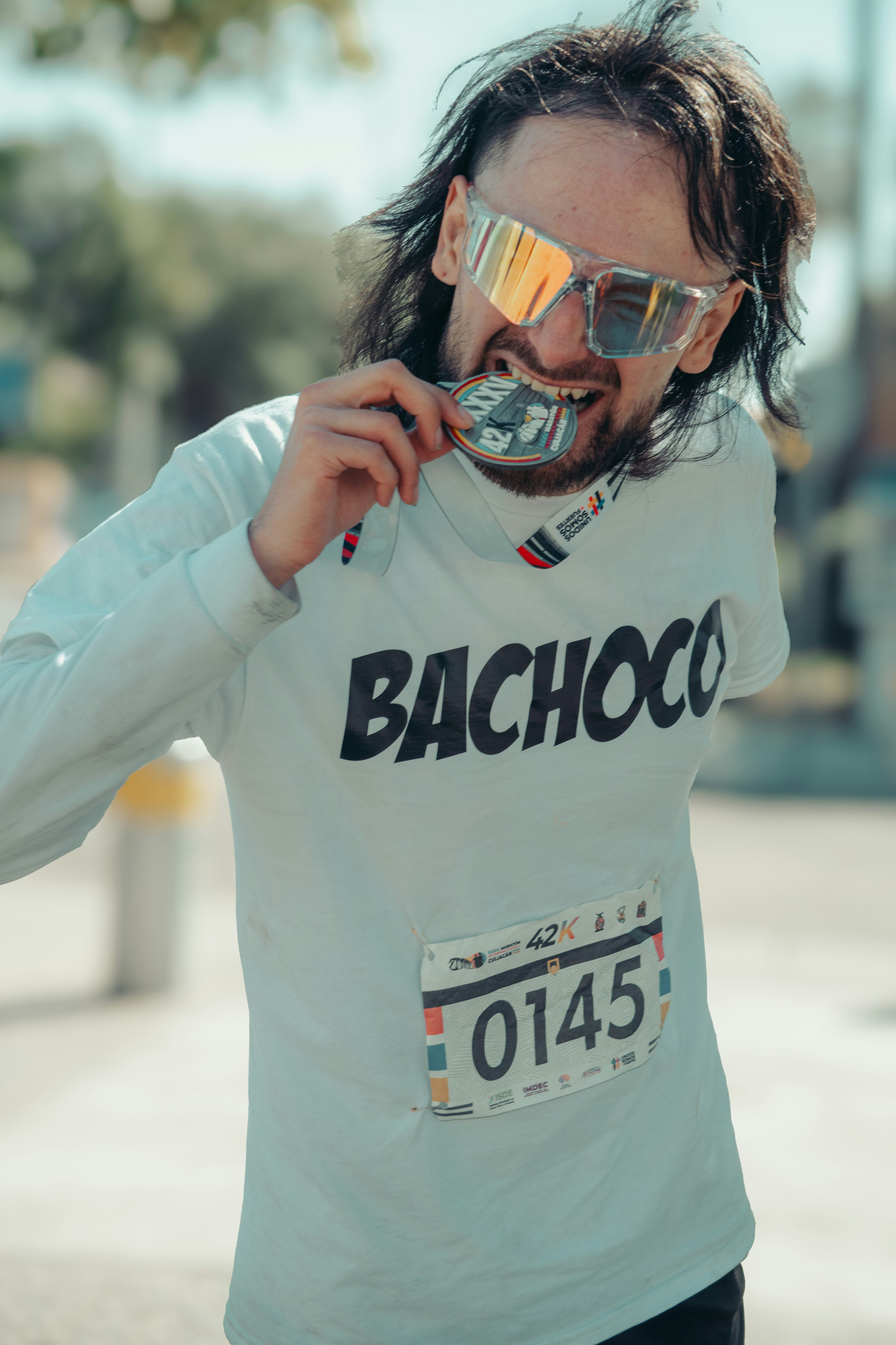 Medal-moment Energized: A Runner Celebrates with a Bite of Victory