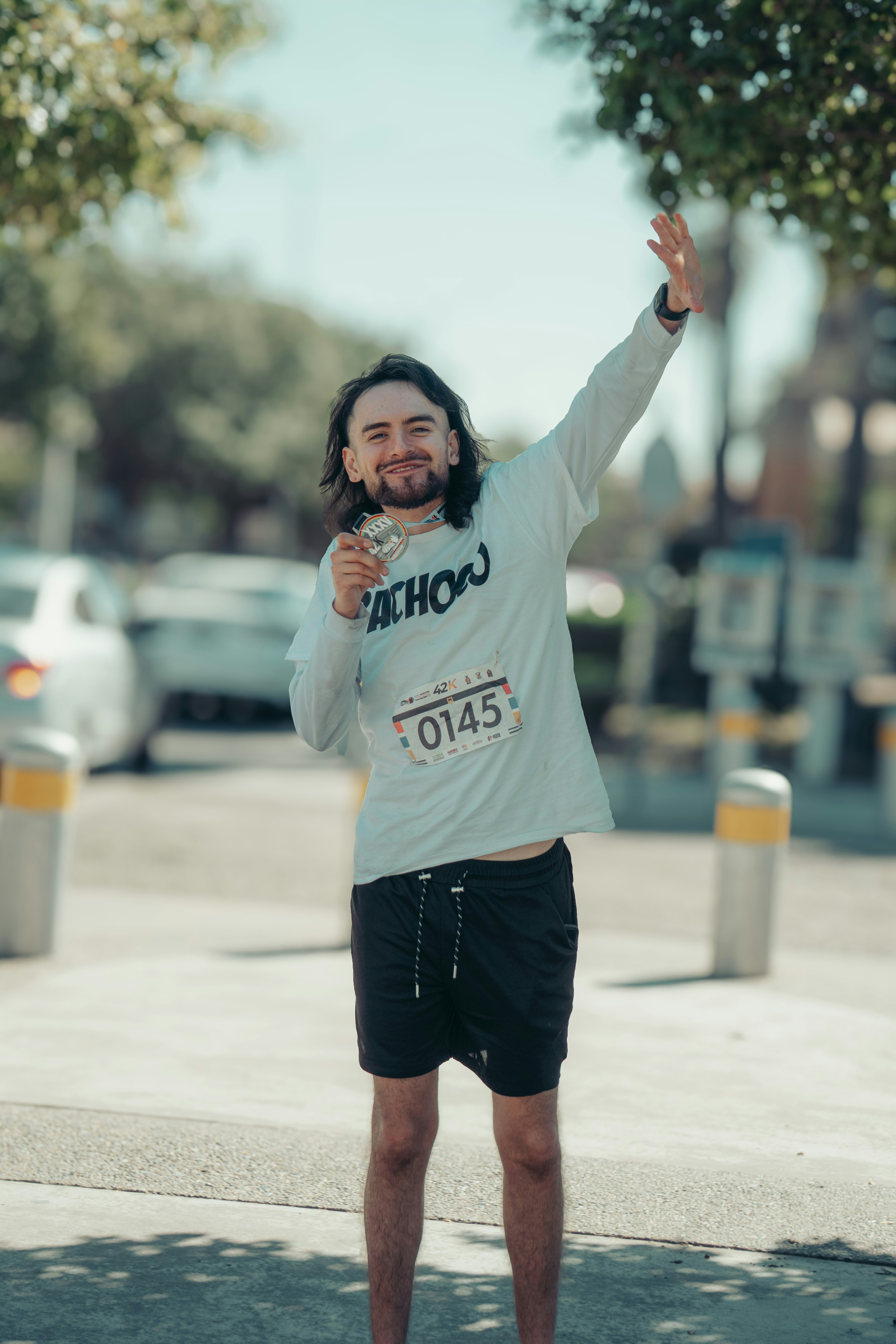 Runner's Victory Wave: A Portrait in Motion