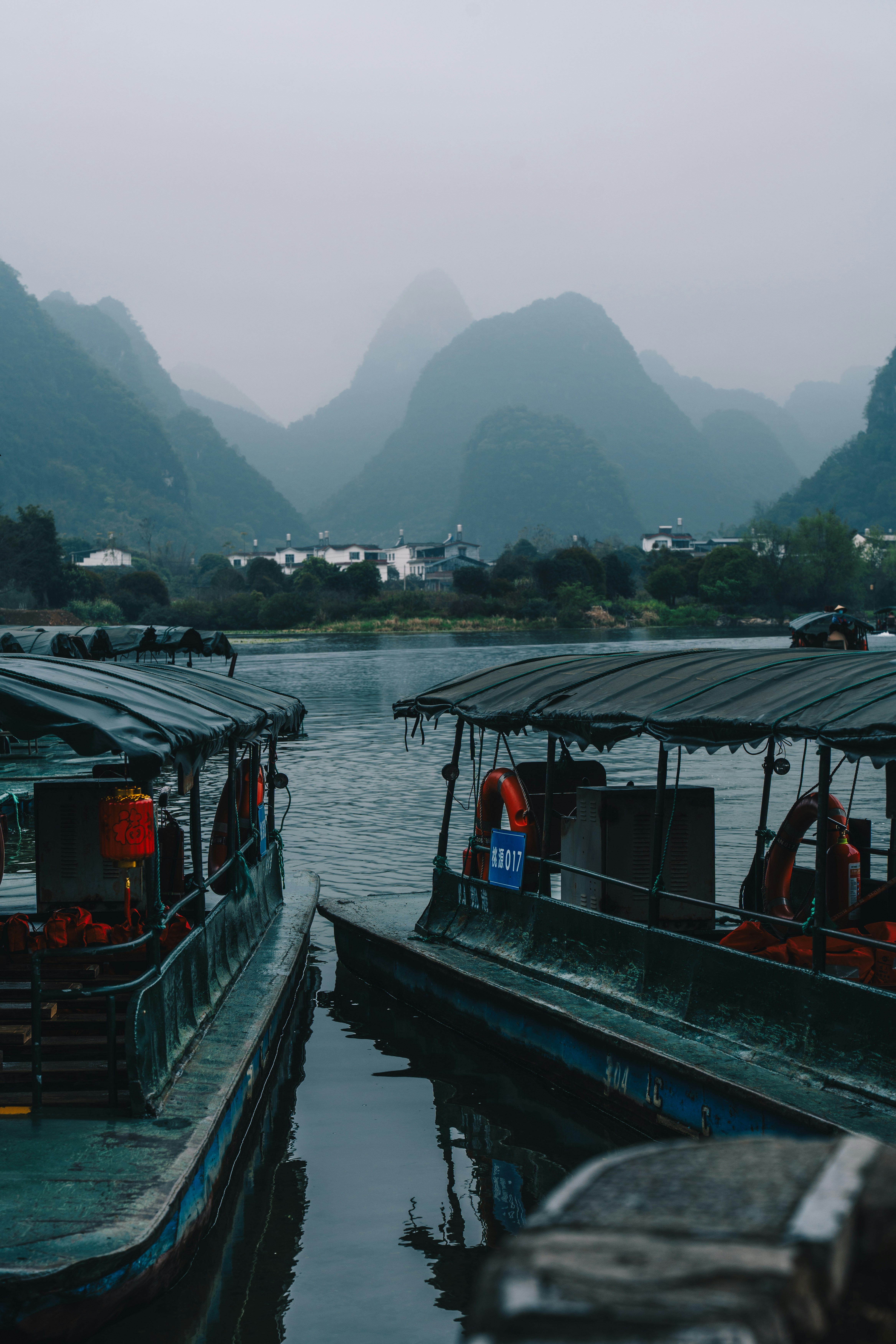Mist Over the River — Boats Rest Along the Quiet Bank