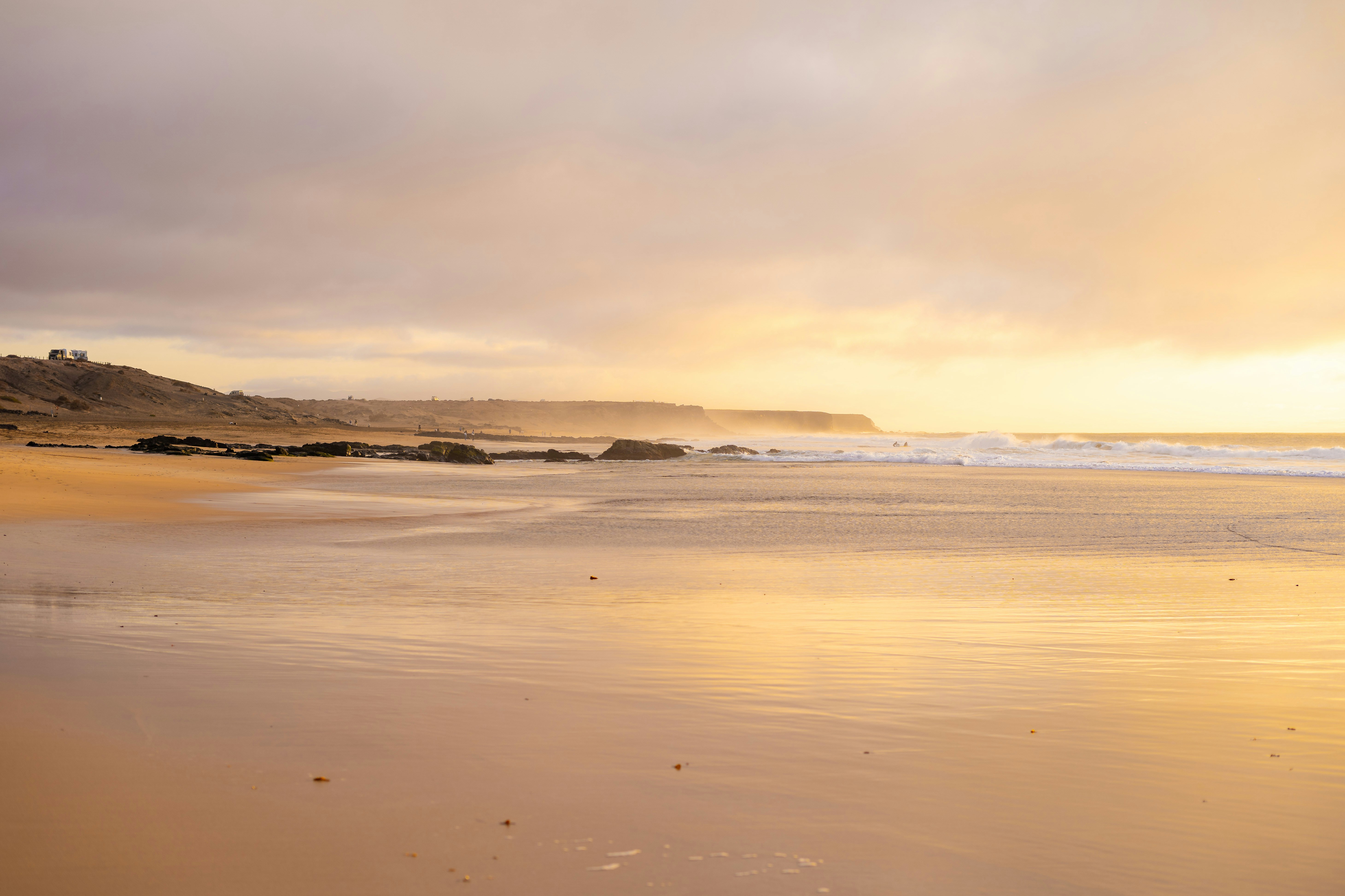 Golden Shoreline: Quiet Light on a Deserted Beach at Dusk