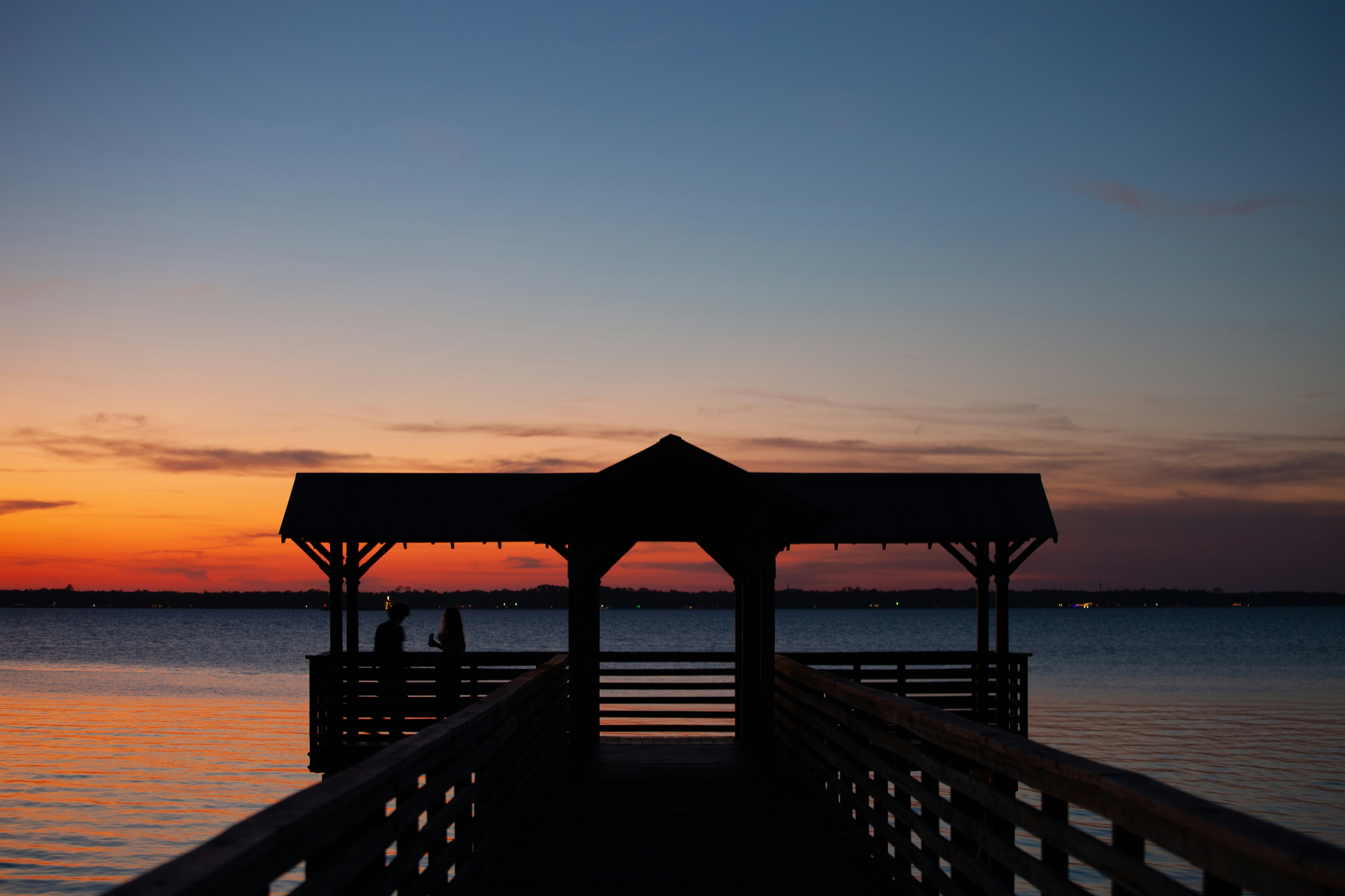 Silhouette Pier to the Sunset: A Dwelling of Light and Shadow