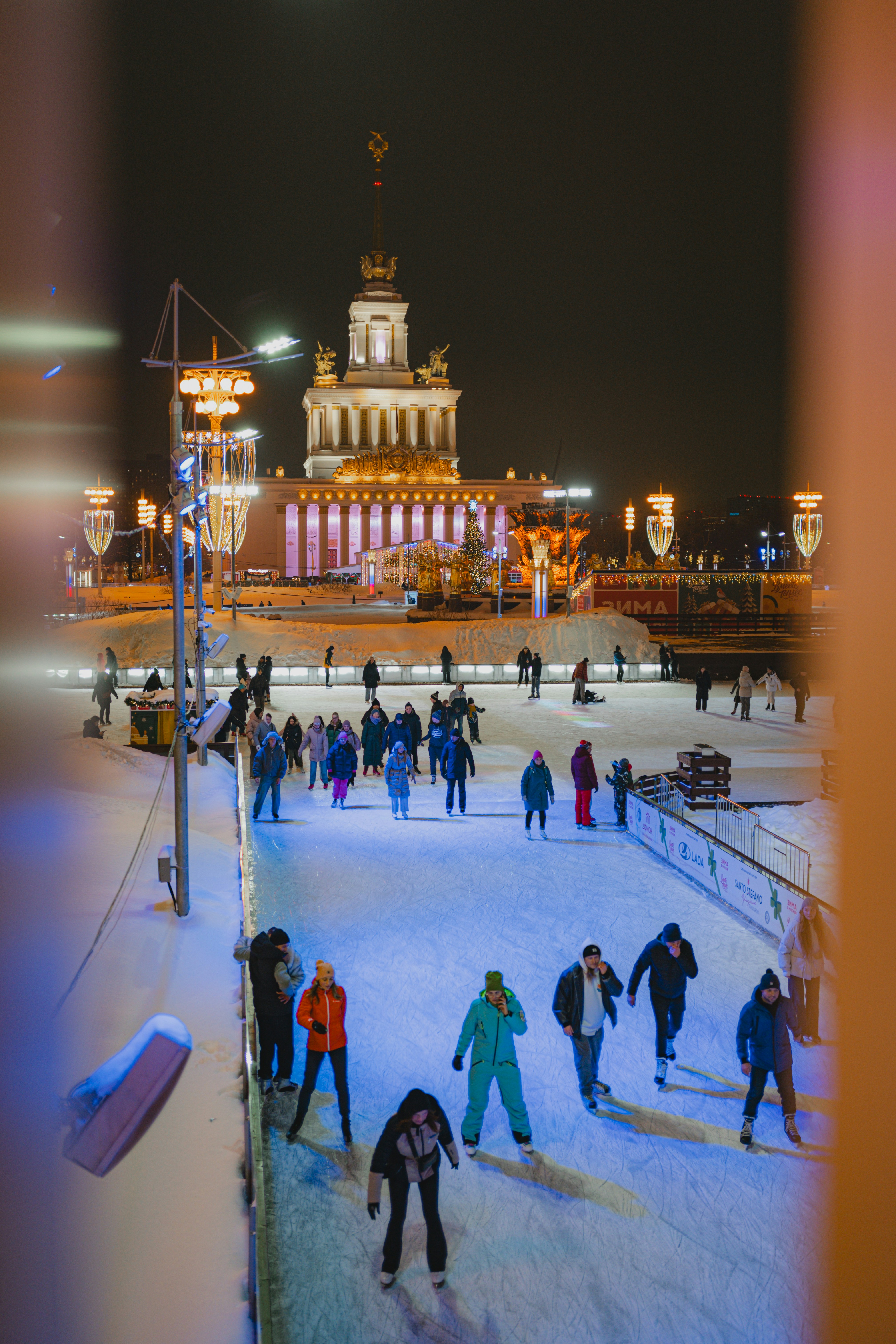 Snowy Night Skaters at a Grand Illuminated Society Building